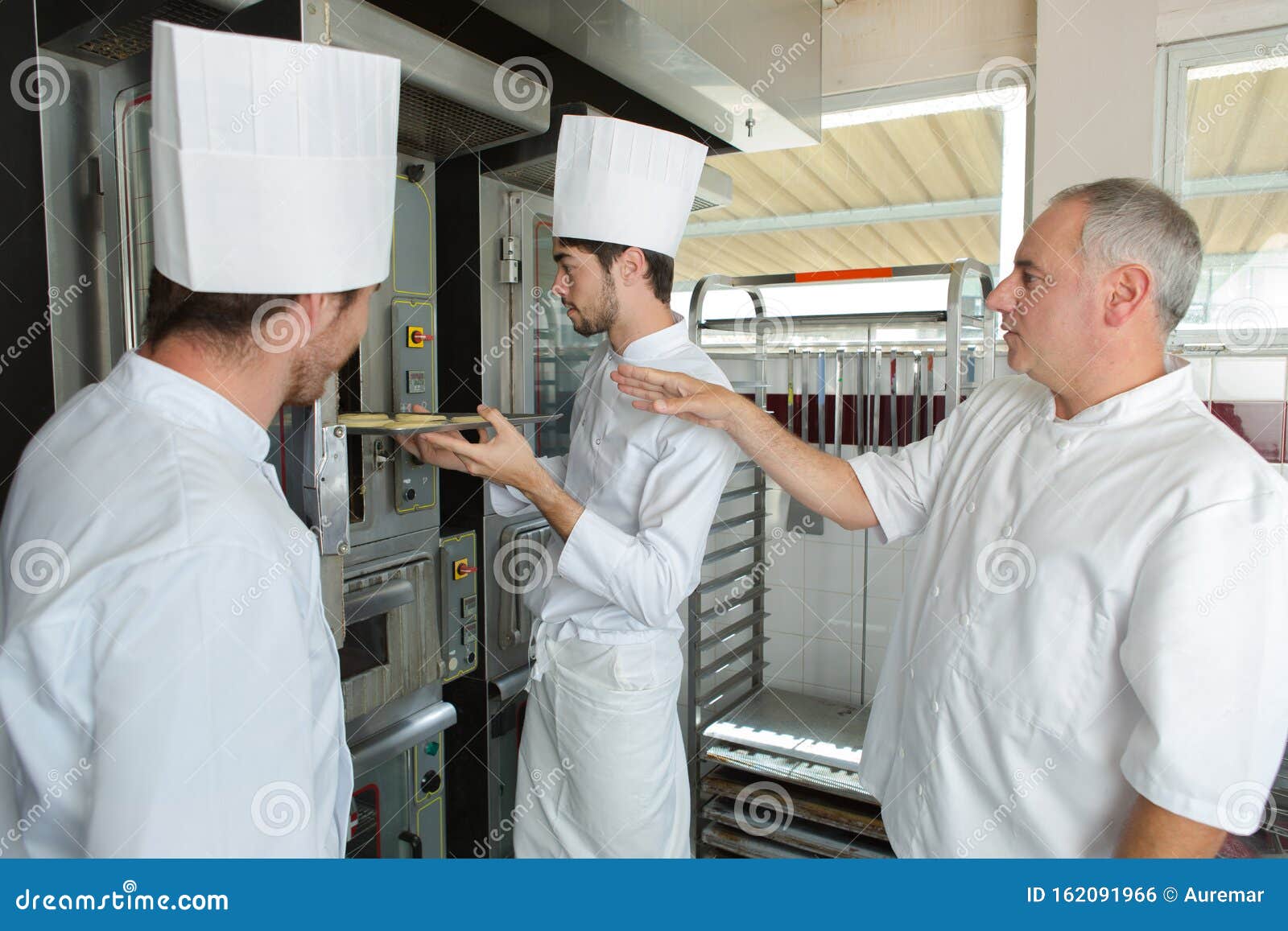 Two Bakers in Bakery or Bakehouse Baking Pretzels Stock Photo - Image ...