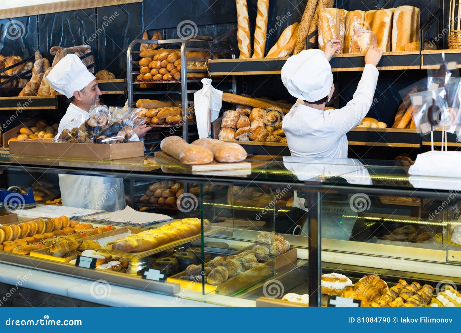Two Bakers at the Counter at Bakery Stock Photo - Image of ...