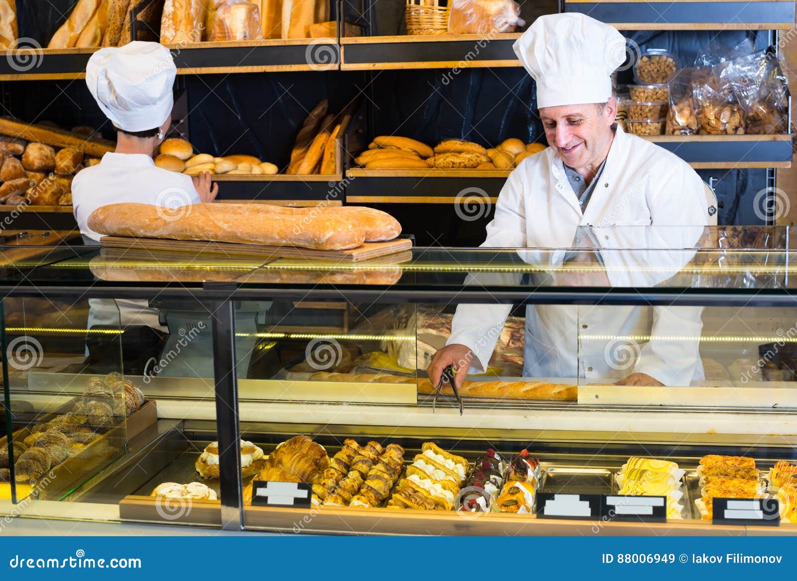 Two Bakers at the Counter at Bakery Stock Image - Image of offer ...