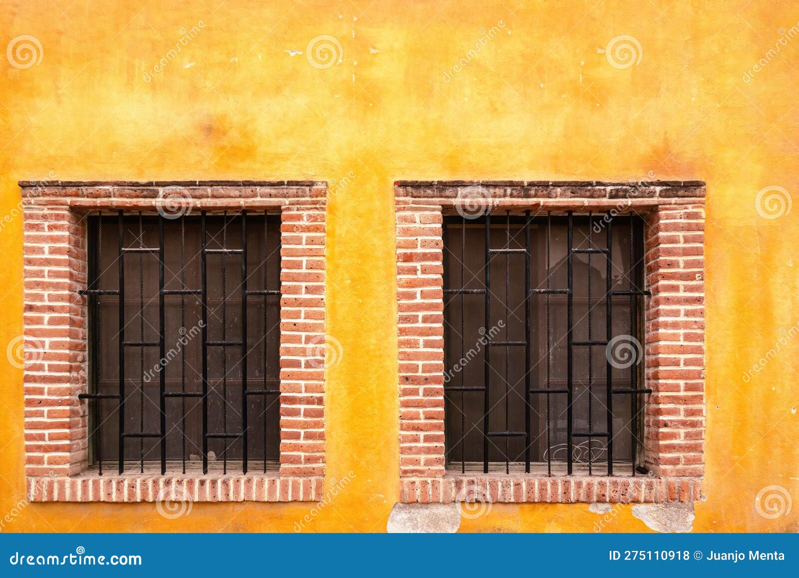 Two Barred Windows with Colorful Paed Mexican Background Stock Photo ...