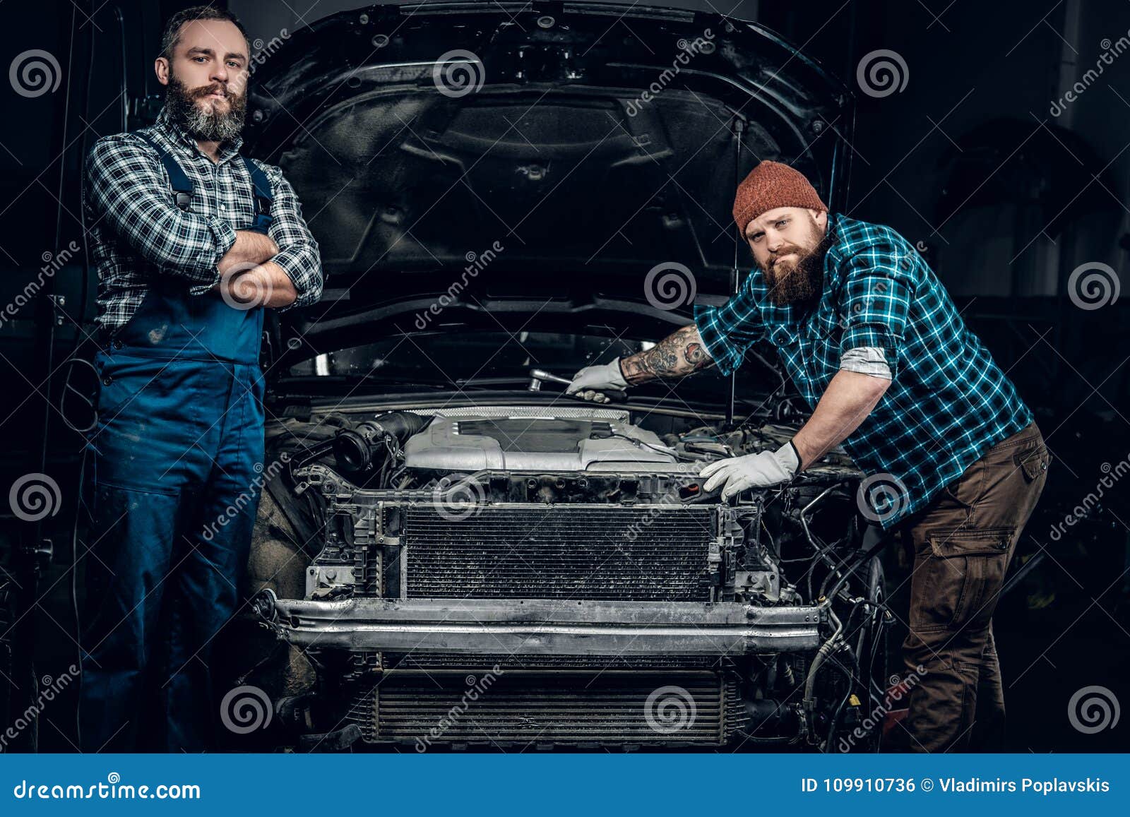 Two men in a garage. stock photo. Image of individuality - 109910736