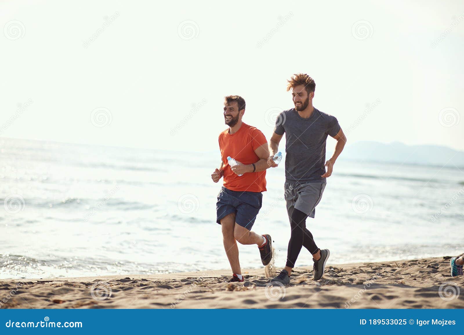 Two Guys Running Along the Beach Coast Stock Image - Image of adult ...