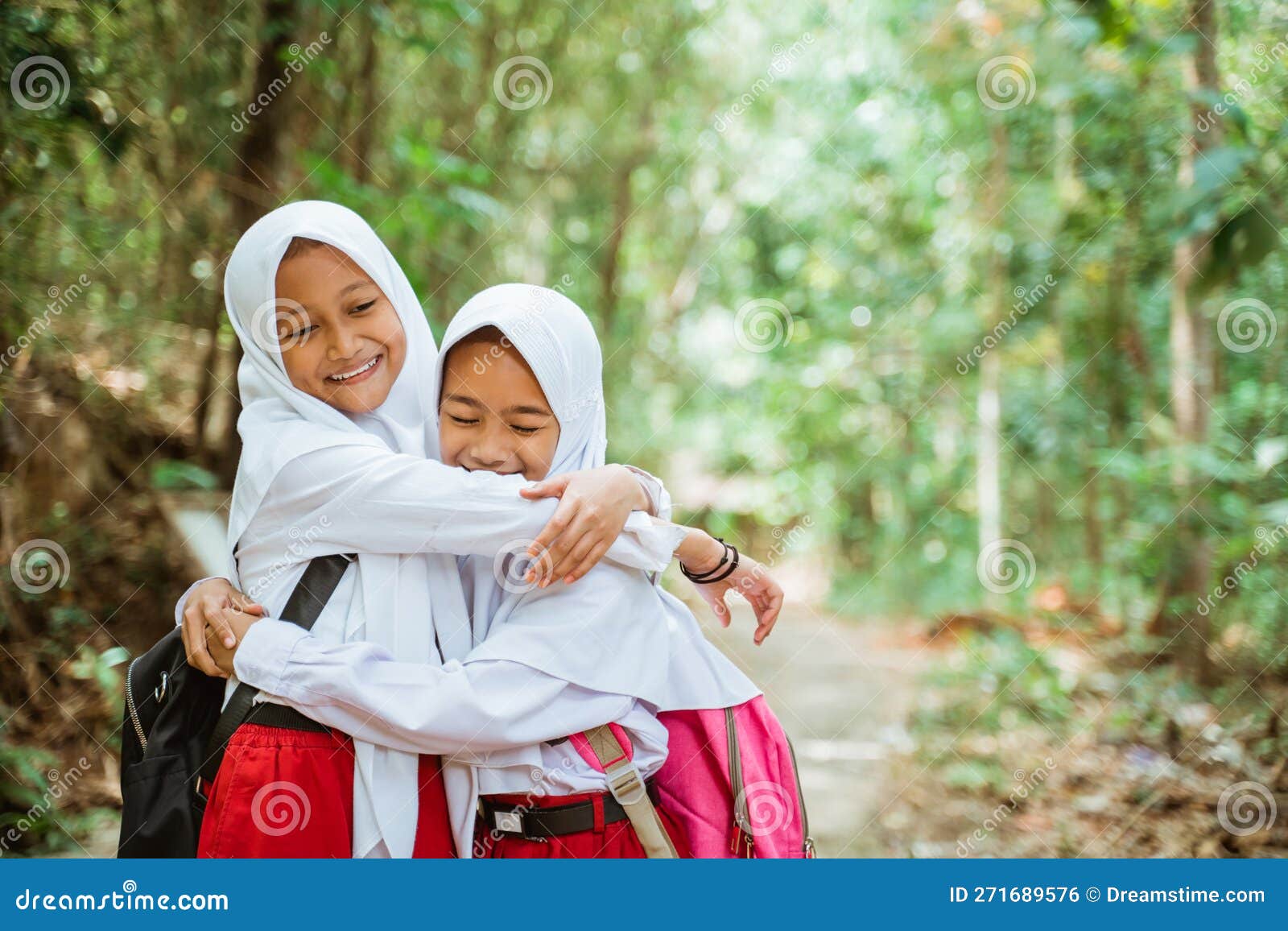 Two Beautiful Elementary Students Standing Together and Hugging Each ...