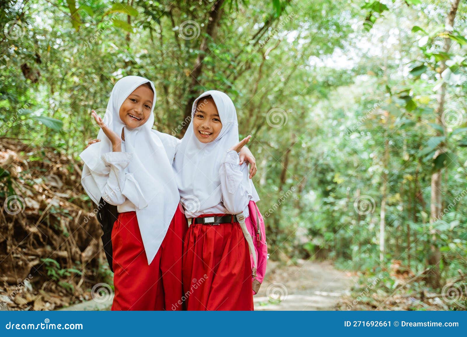 Two Beautiful Elementary Students Standing Together and Hugging Each ...
