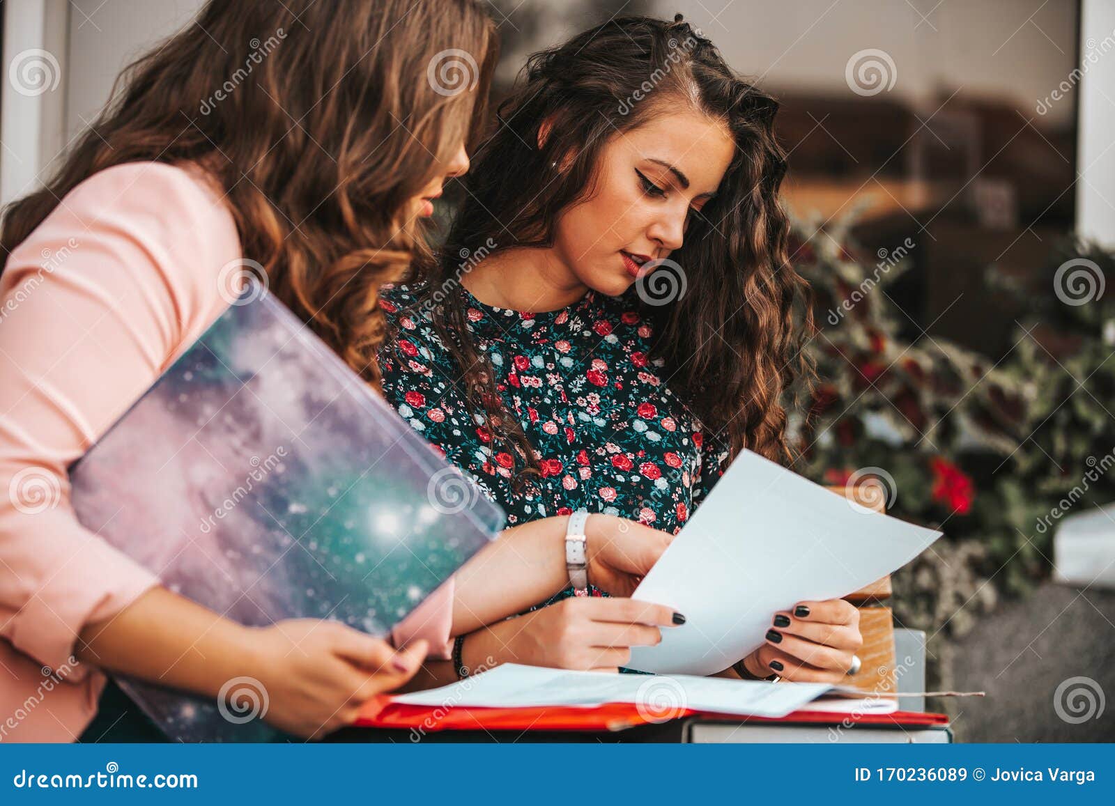 Two Happy Female Friends Studying Reading Notes Sitting on a Bench ...