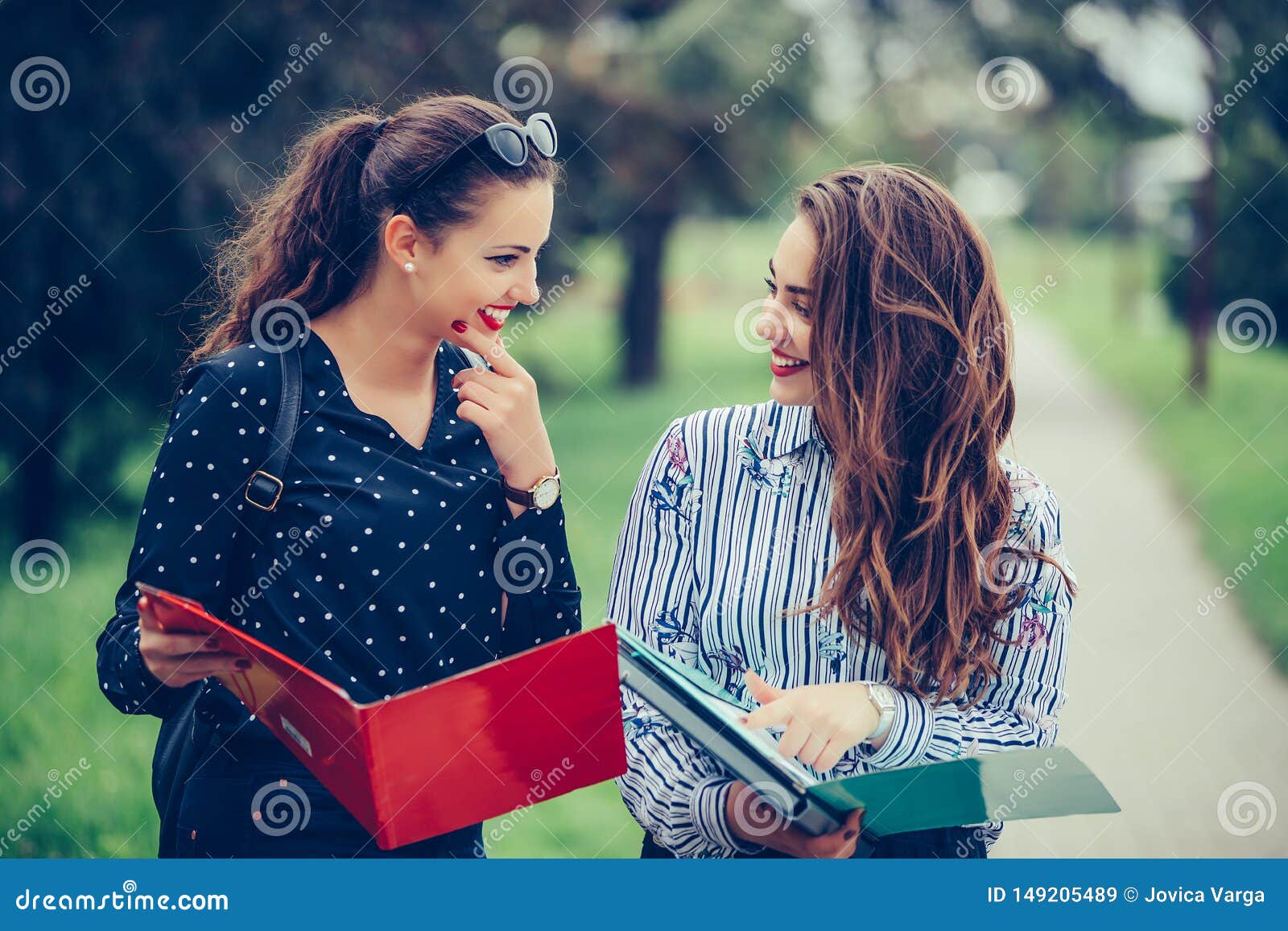 Two Beautiful Female Friends, Students Checking Paper Notes before Exam ...