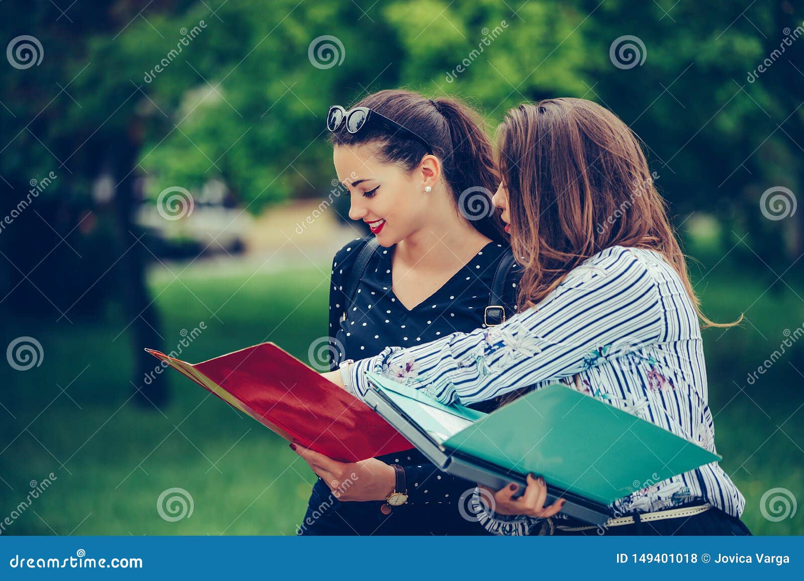 Two Beautiful Female Friends, Students Checking Paper Notes before Exam ...