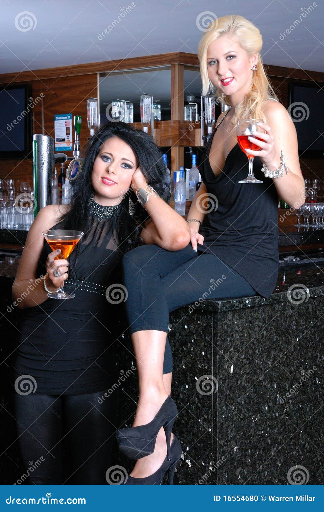 Two beautiful girls in bar stock photo. Image of seat - 16554680