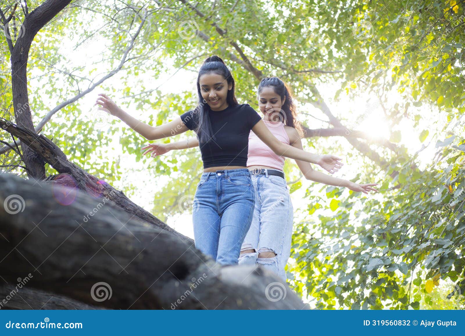 Two Beautiful Girls Standing on a Tree Stock Photo - Image of chilling ...