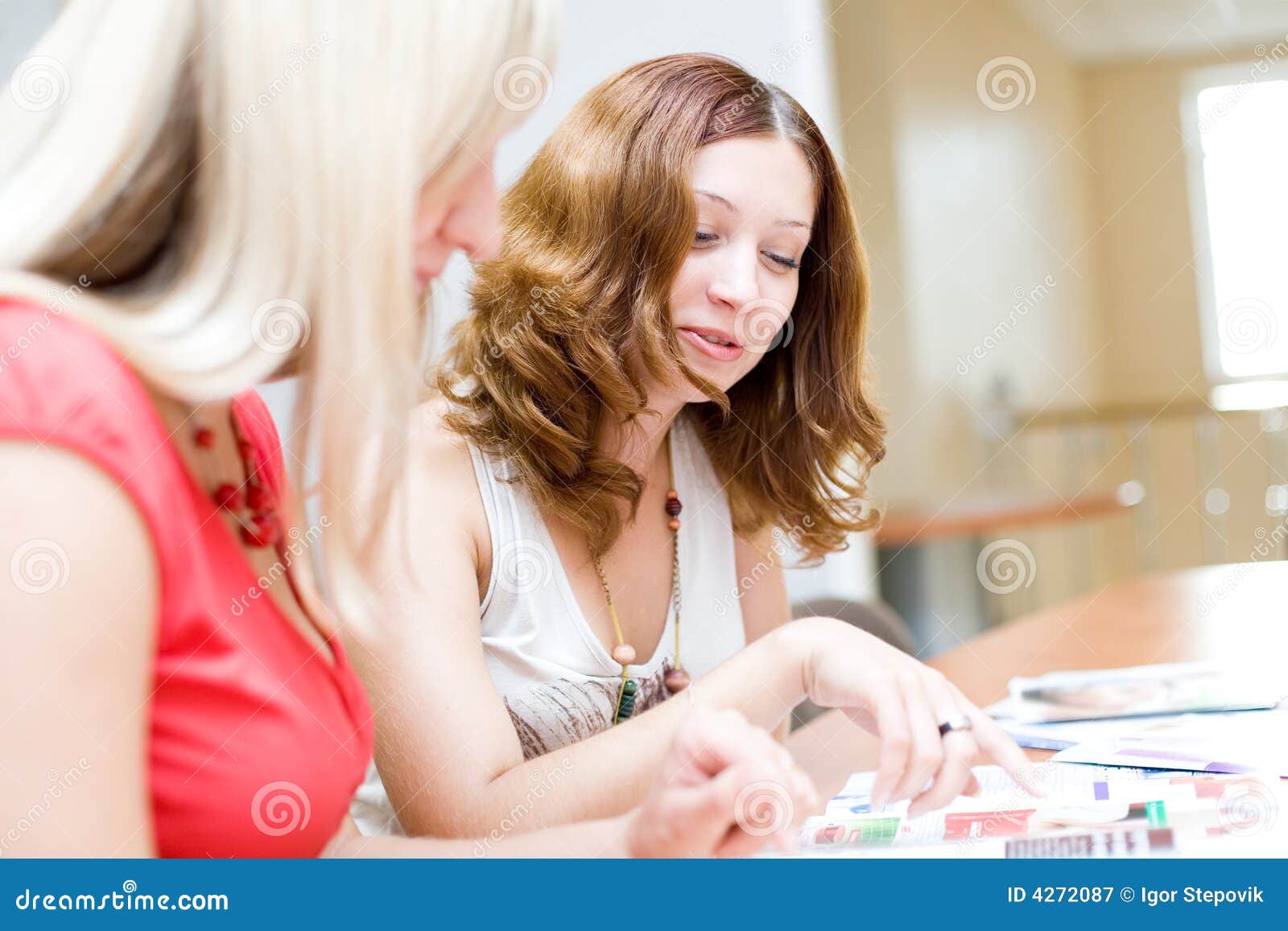 Two Beautiful Girls Discuss the Magazine Stock Image - Image of ...