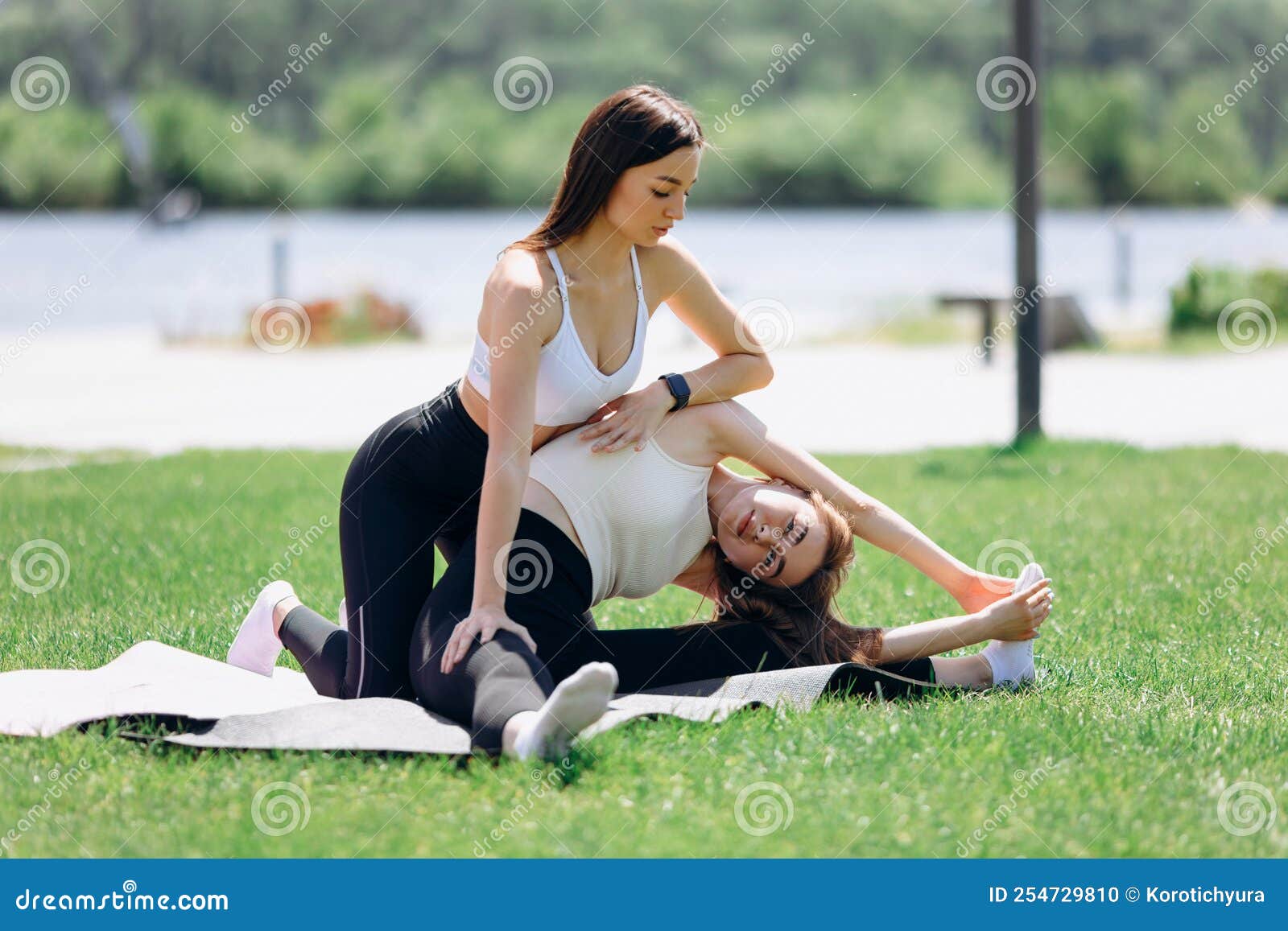 Two Beautiful Girls Do Exercises Outdoors in the Park Stock Photo ...