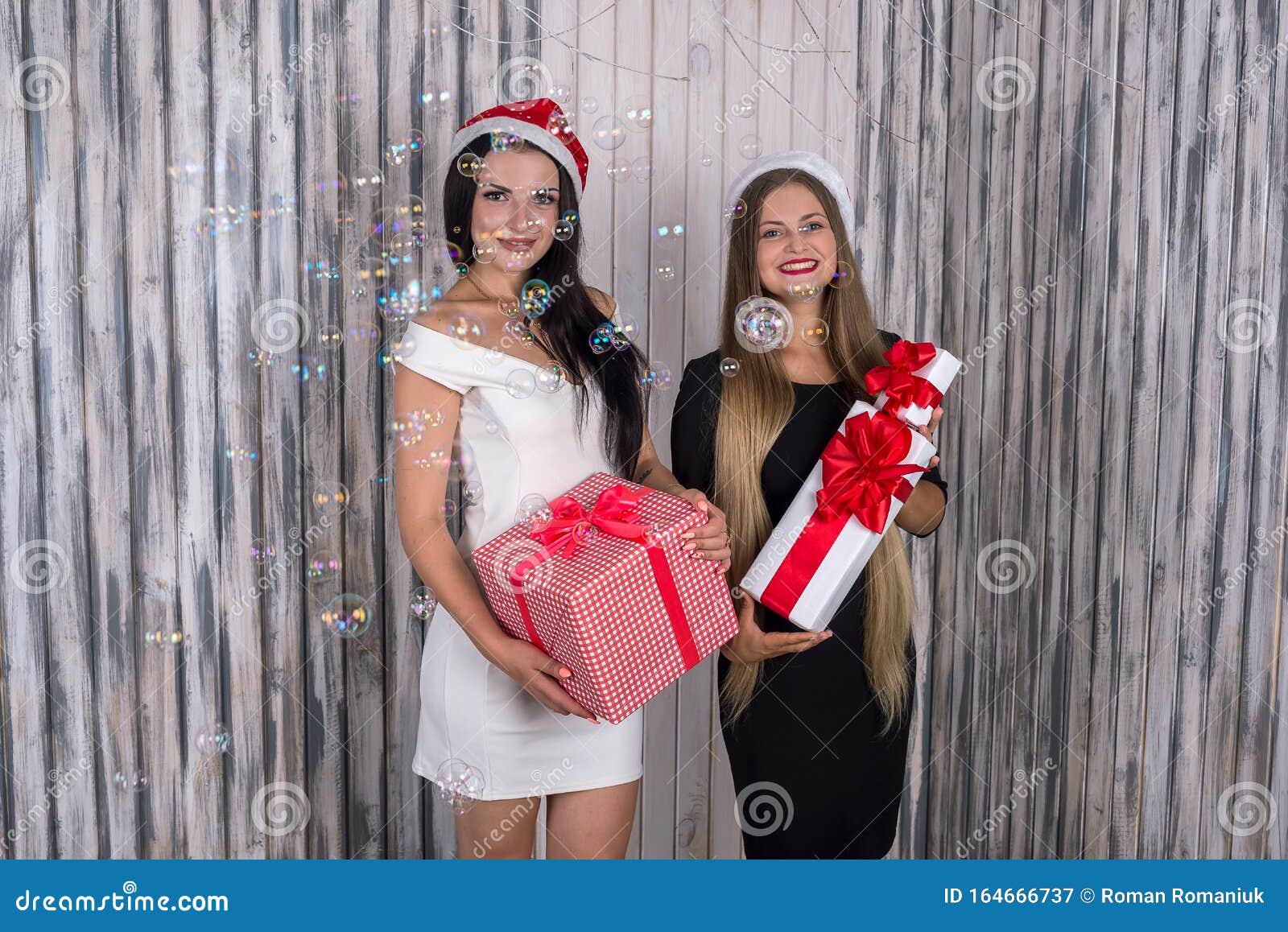 Two Beautiful Girls with Present Boxes Posing in Studio Stock Image ...