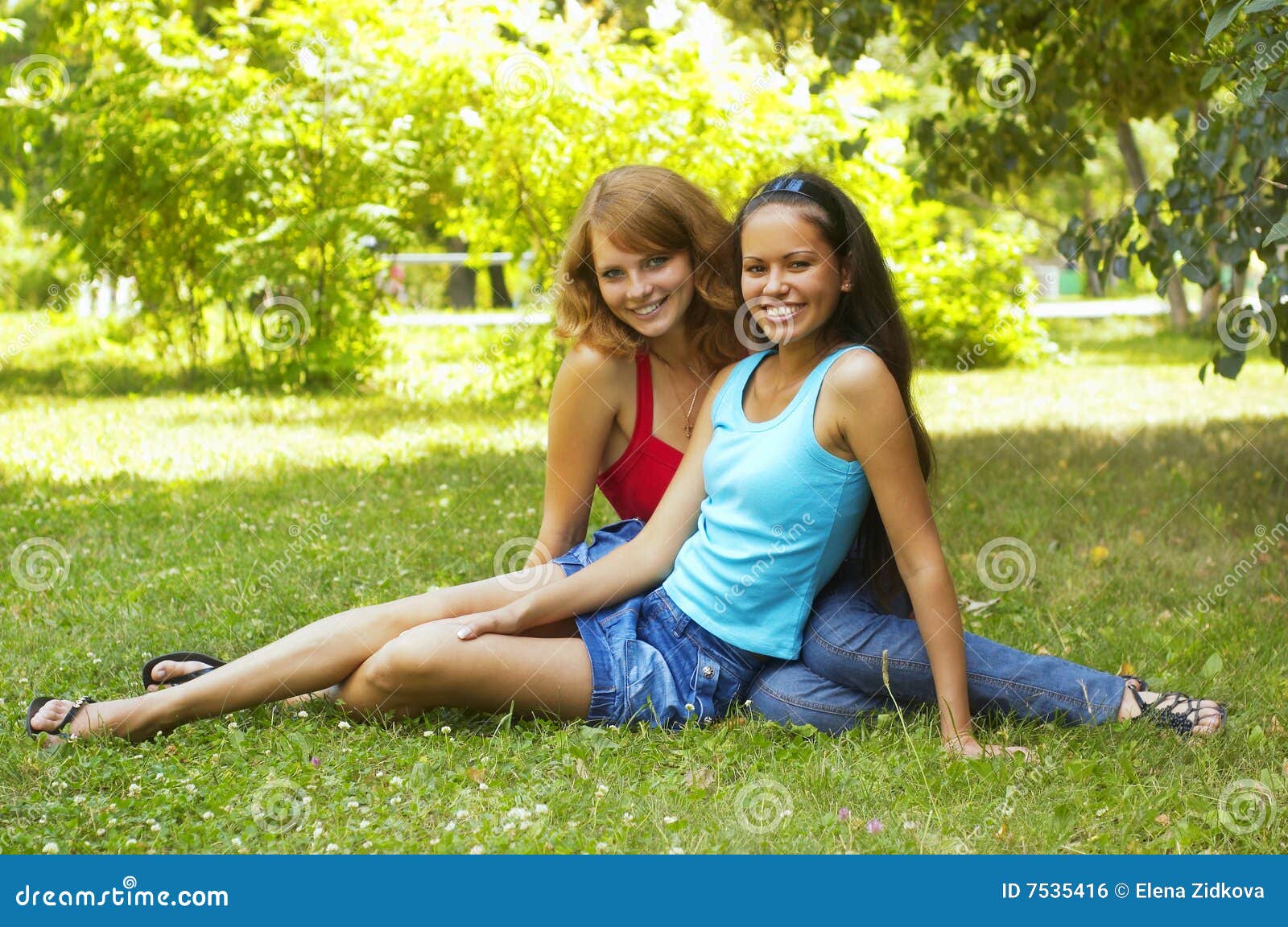 Two Beautiful Girls Sit in Park Stock Photo - Image of external, green ...