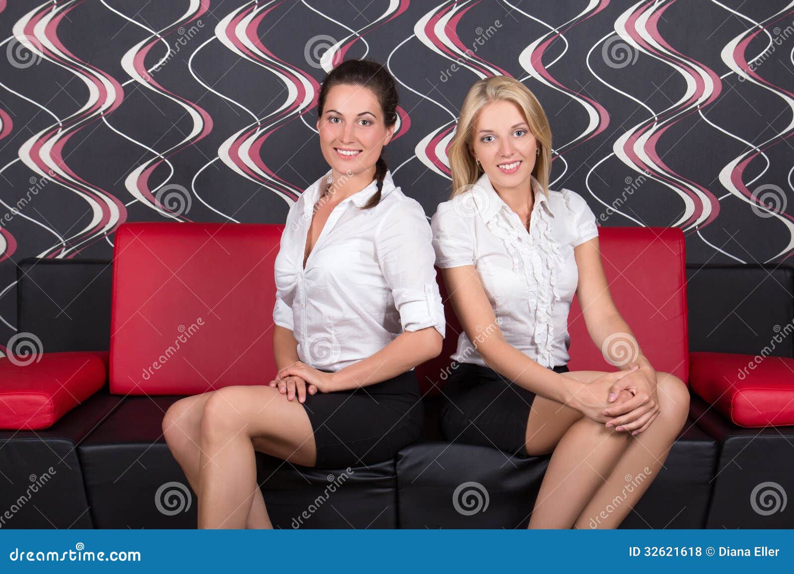Two Beautiful Girls Sitting on the Sofa Stock Photo - Image of ...