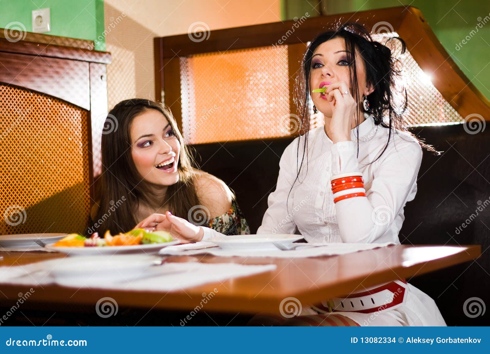 Two Beautiful Girls at Table Stock Photo - Image of laughing, design ...