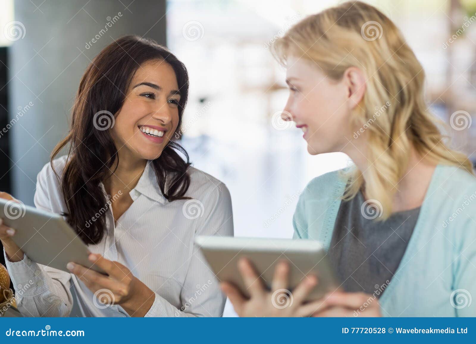 Two Beautiful Women Interacting with Each Other while Using Laptop ...