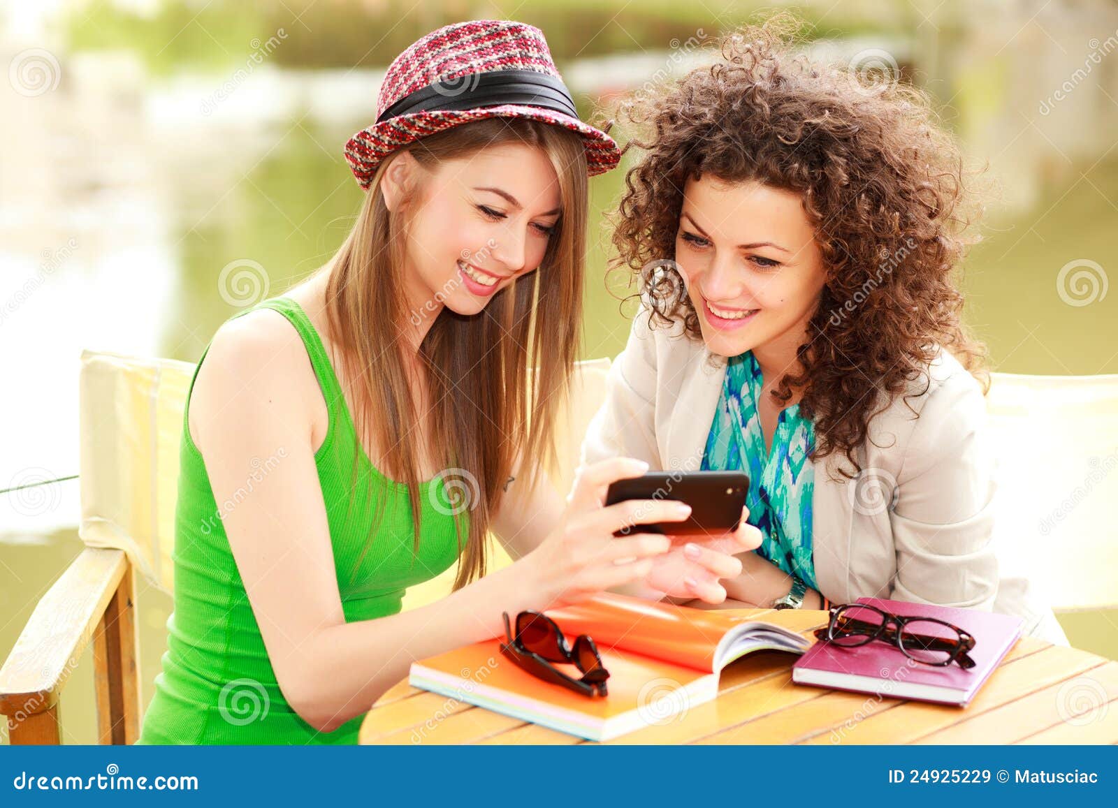 Two Beautiful Women Playing on a Smart-phone Stock Image - Image of ...