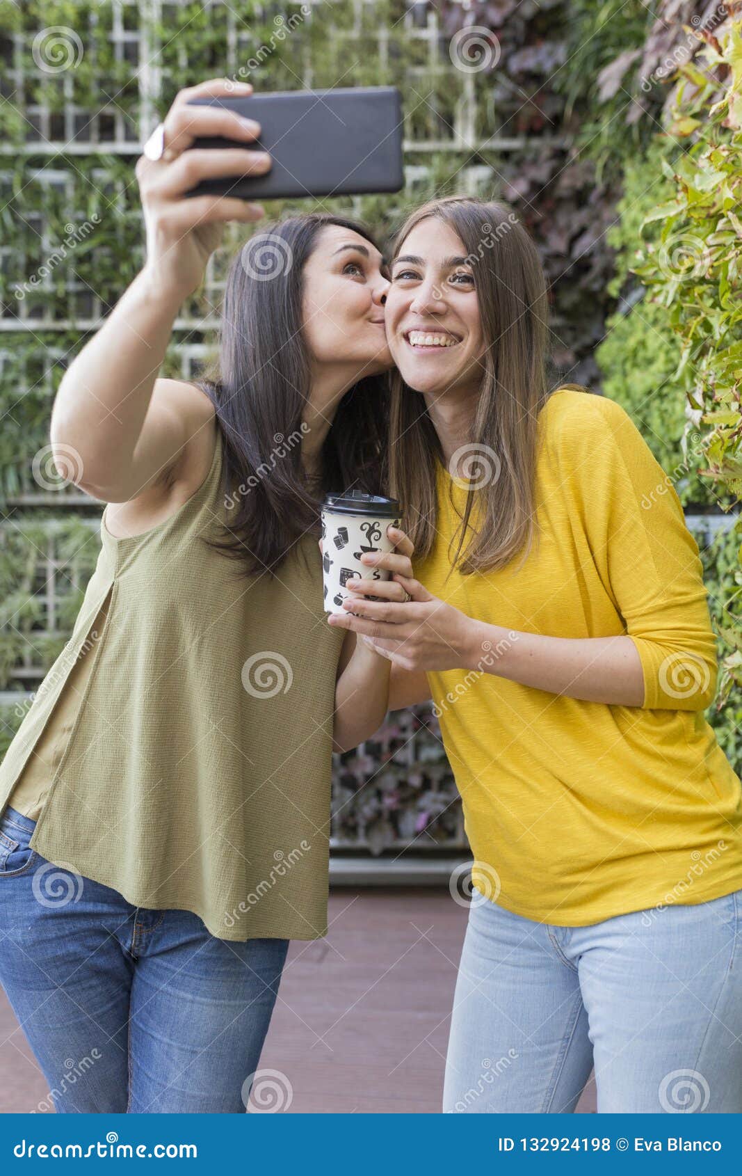 Two Beautiful Women Taking A Selfie With Mobile Phone One Is Holding A
