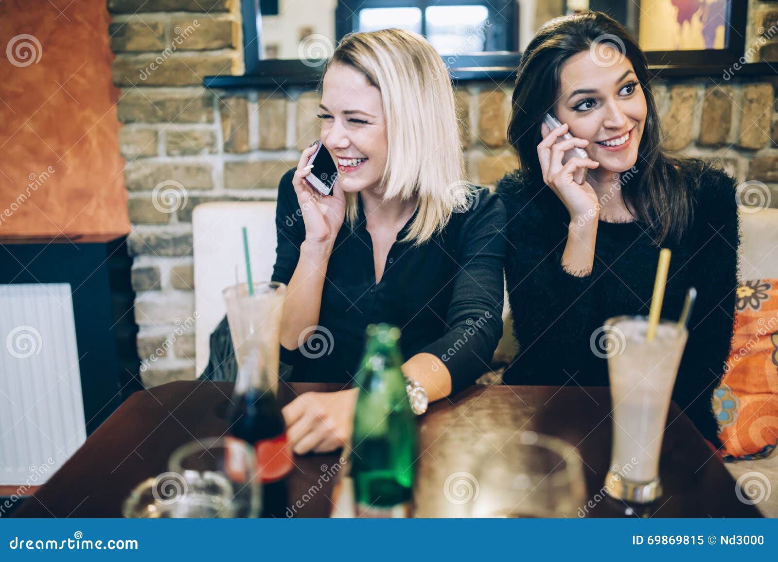 Two Beautiful Women Talking on Phone in Cafe Stock Image - Image of ...