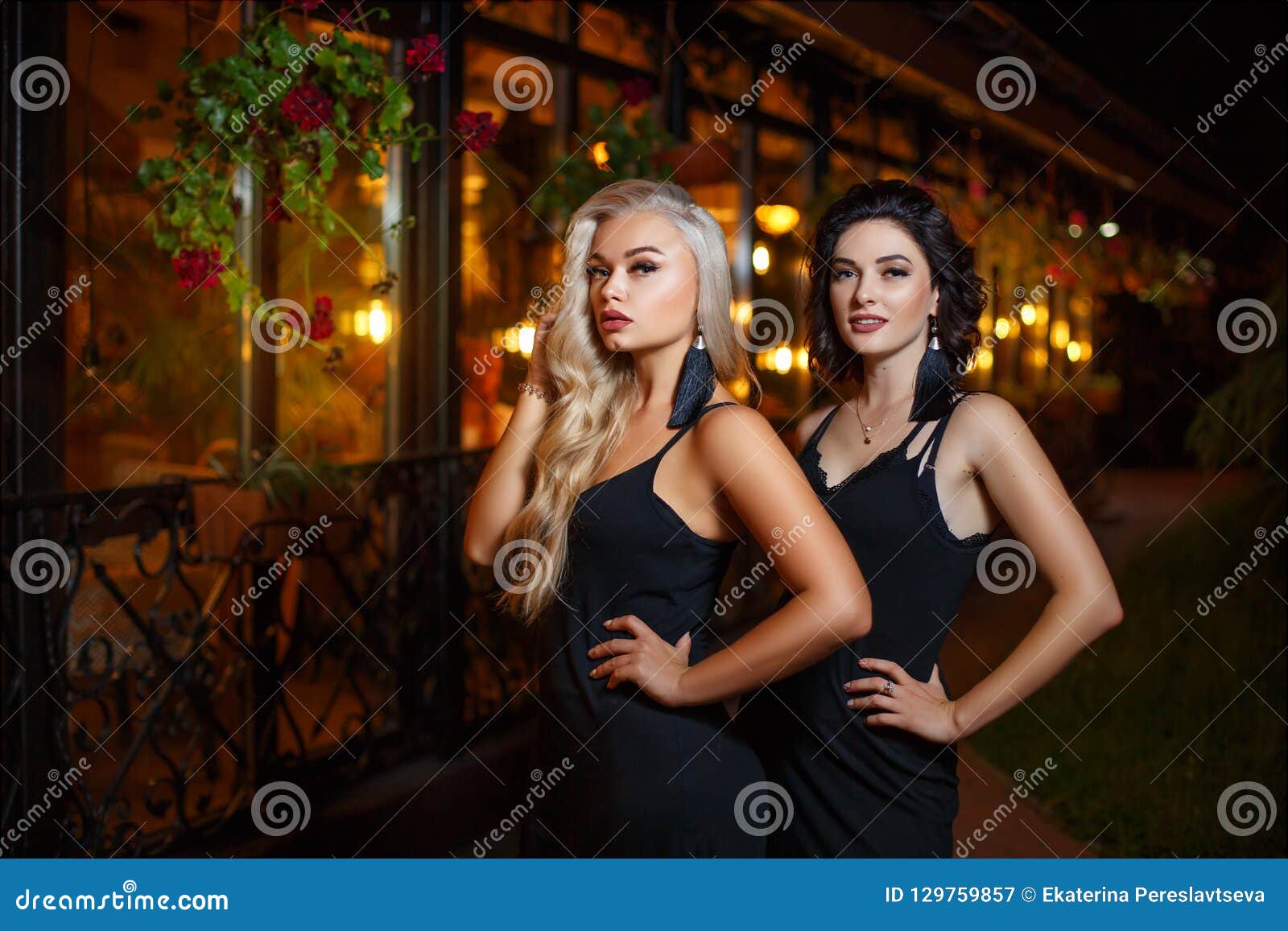 Two Beautiful Young Female Friends Posing Outside in the Evening Stock ...