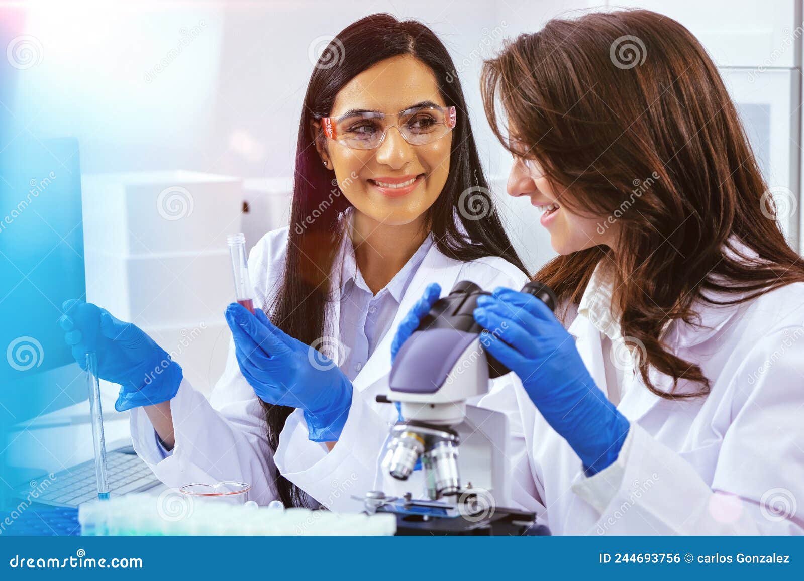 Two Beautiful Young Female Scientists Working in Laboratory with Test ...