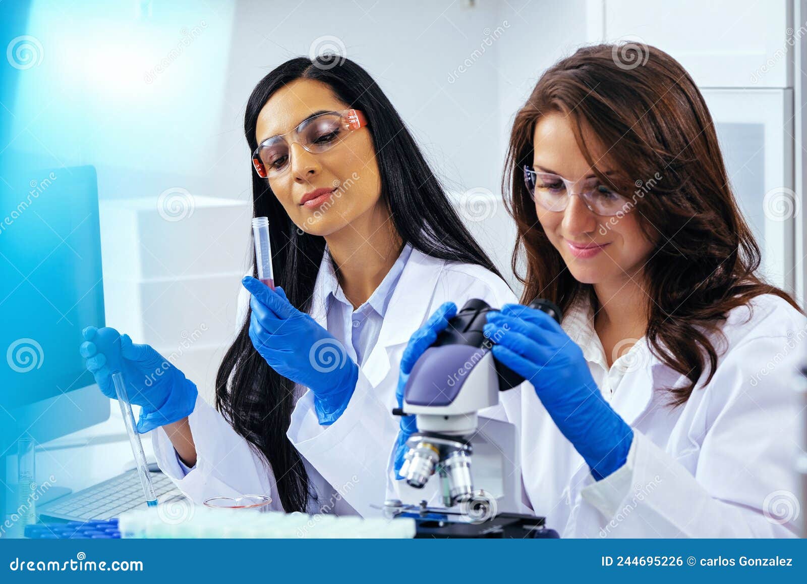 Two Beautiful Young Female Scientists Working in Laboratory with Test ...