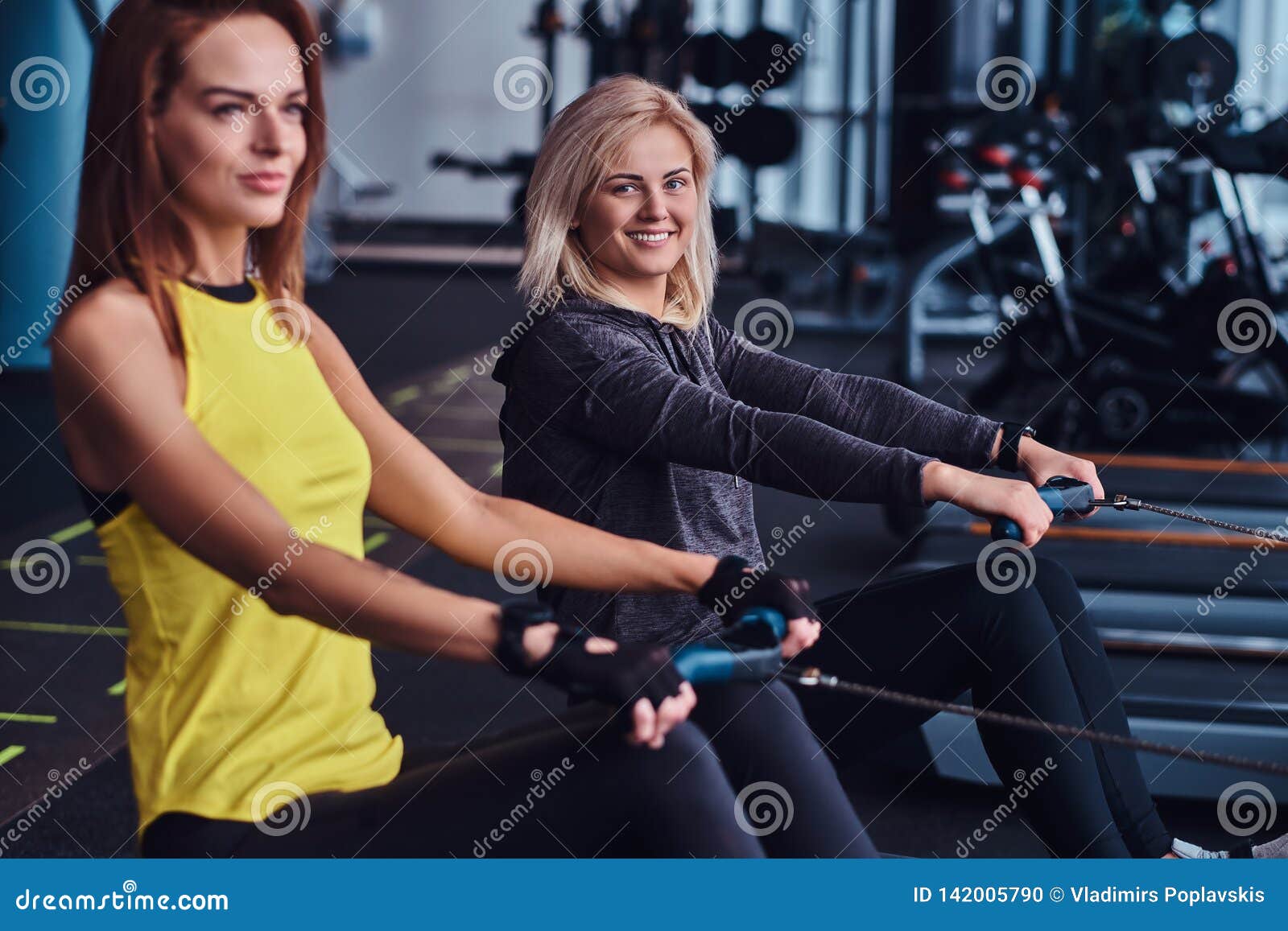 Two Beautiful Young Women Doing Rowing Practice in the Gym Stock Photo ...