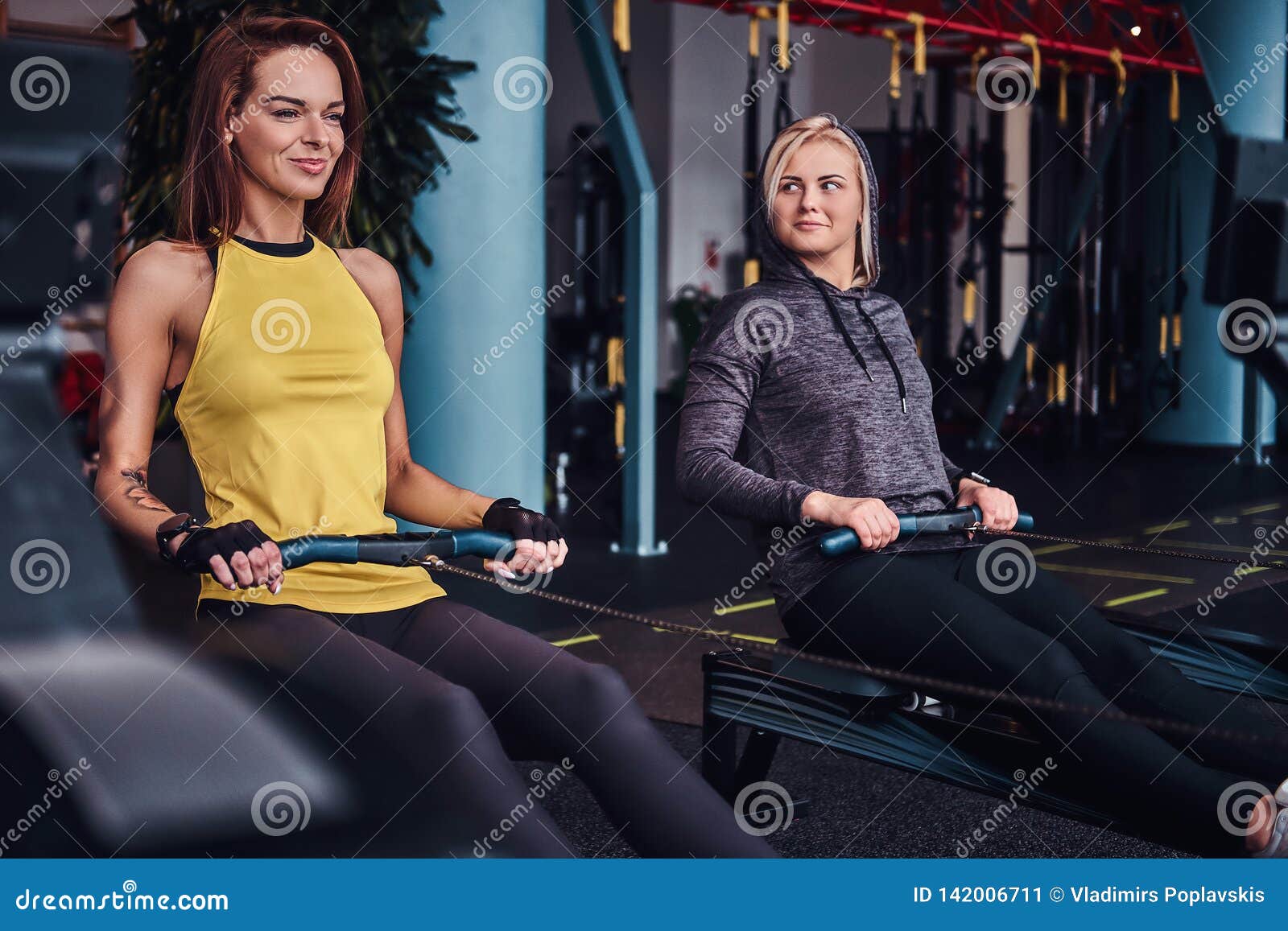 Two Beautiful Young Women Doing Rowing Practice in the Gym Stock Image ...