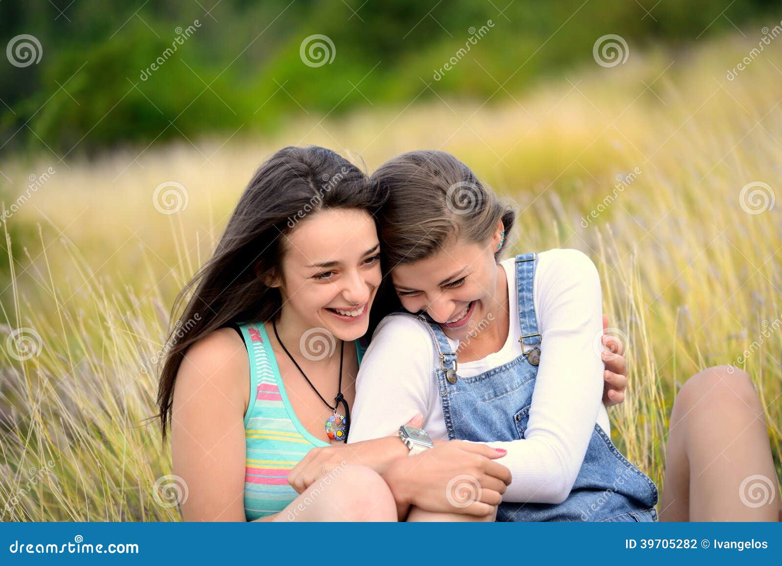 Two Beautiful Young Women Laughing on Dry Grass Stock Photo - Image of ...
