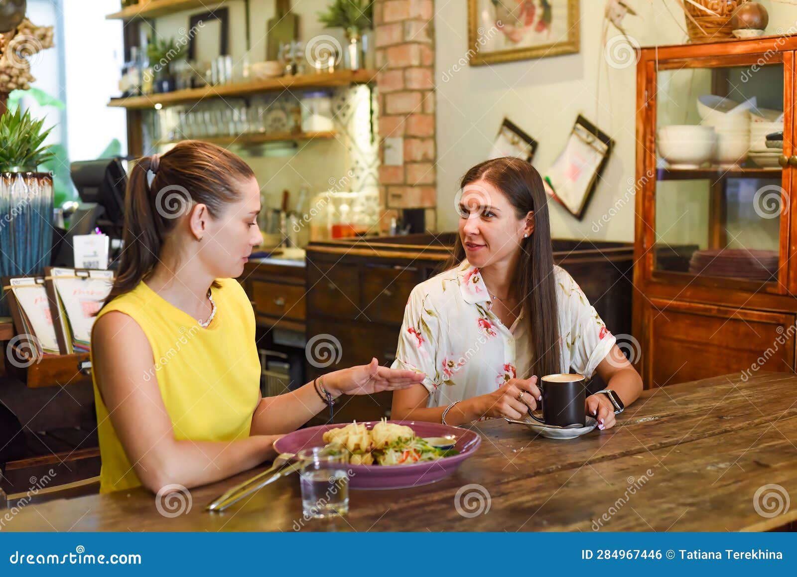 Two Best Friends Talking and Eating in a Cafe Stock Photo - Image of ...