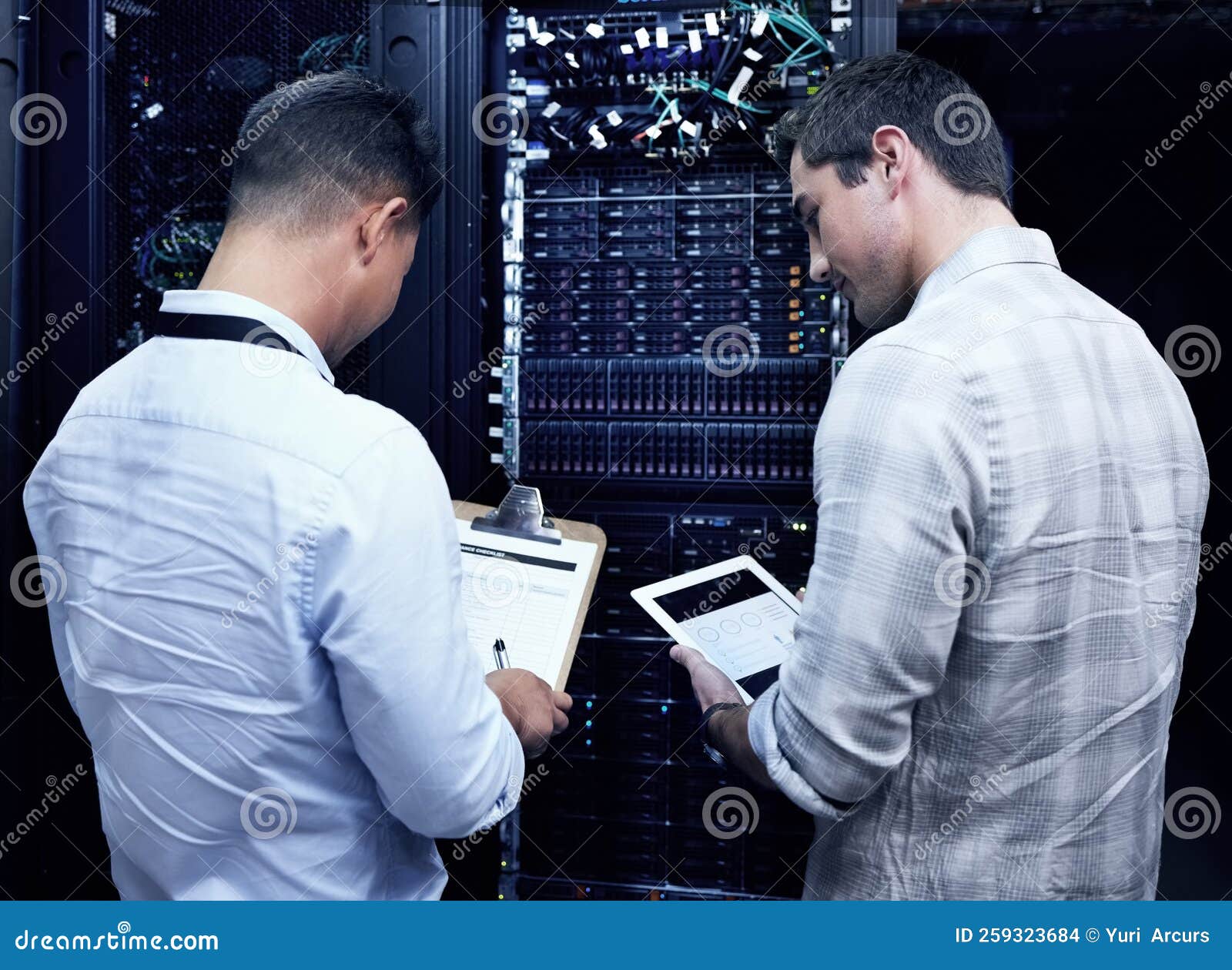 Two of the Best Tech Gurus in Town. Two Technicians Working Together in ...
