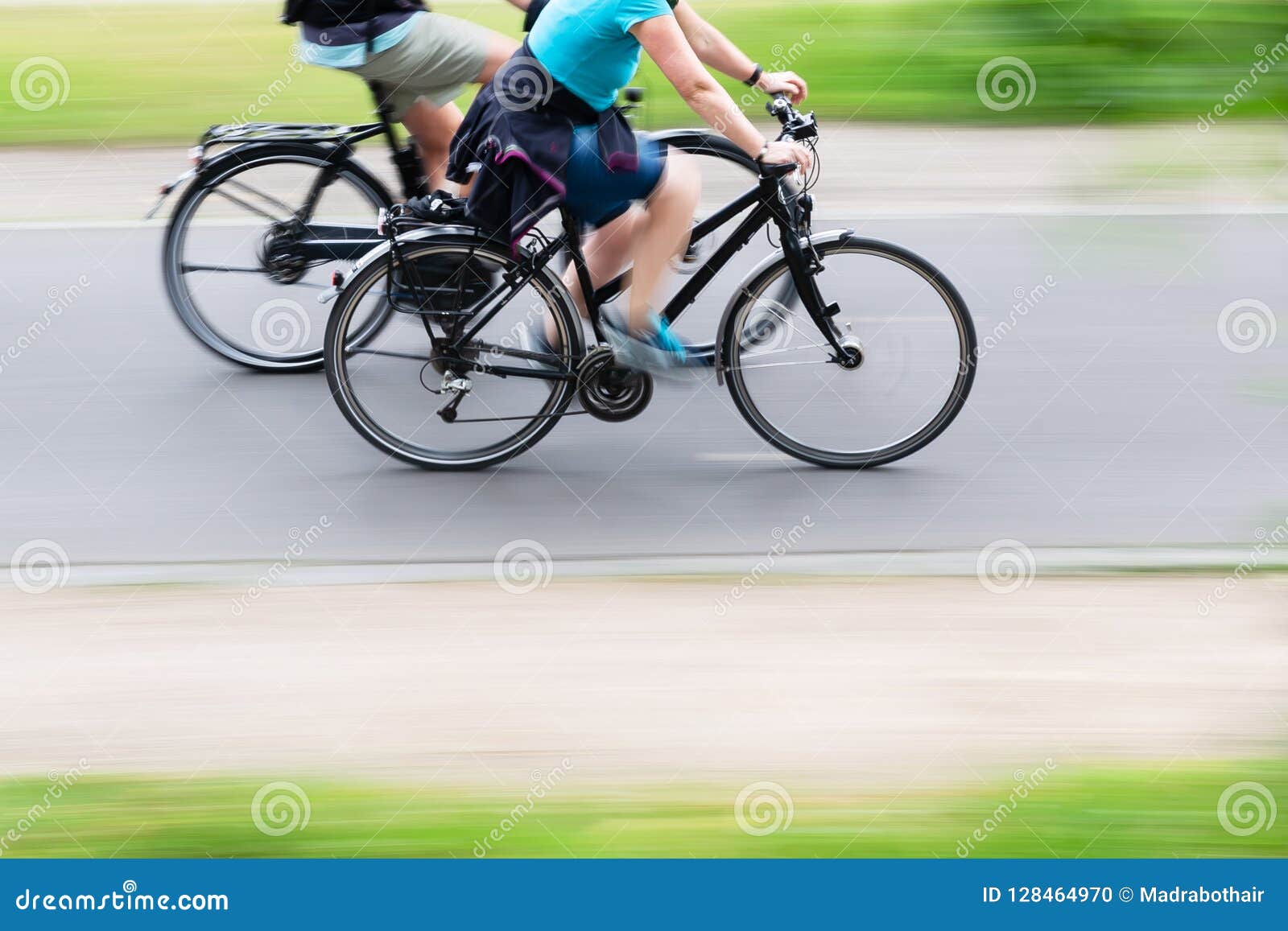 Two Bicycle Riders on a Cycle Path in Motion Blur Stock Photo - Image ...