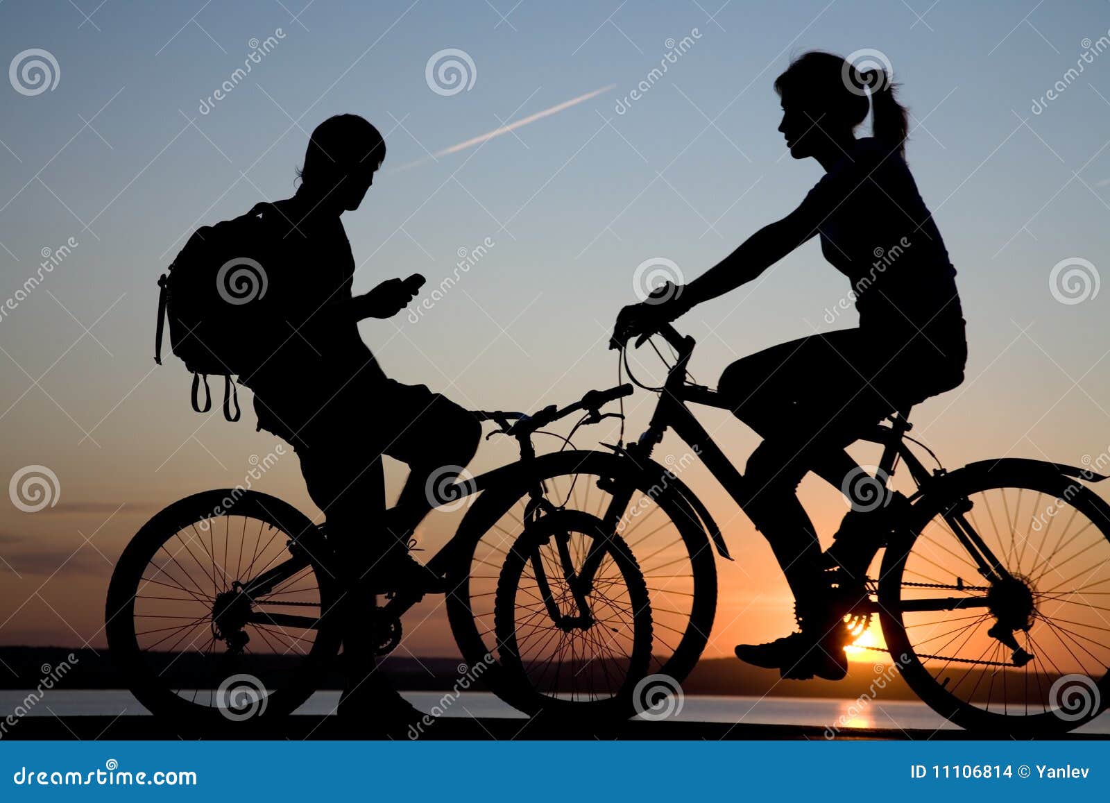 Two bicycler on sunset stock photo. Image of coast, connected - 11106814