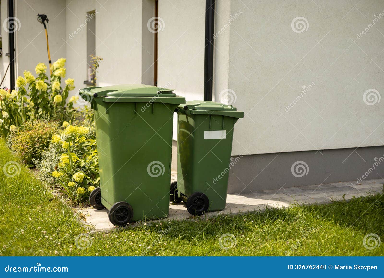 Two Big Empty Green Plastic Trash Garbage Bin in Front of the Modern ...
