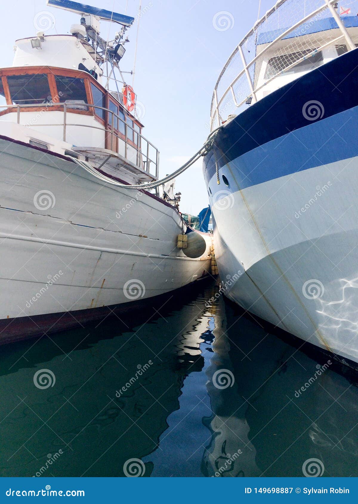 Two Big Fishing Boats Tied Up in Port Dock Marina Detail with Water ... Two Big Fishing Boats Tied Up in Port Dock Marina Detail with Water ...