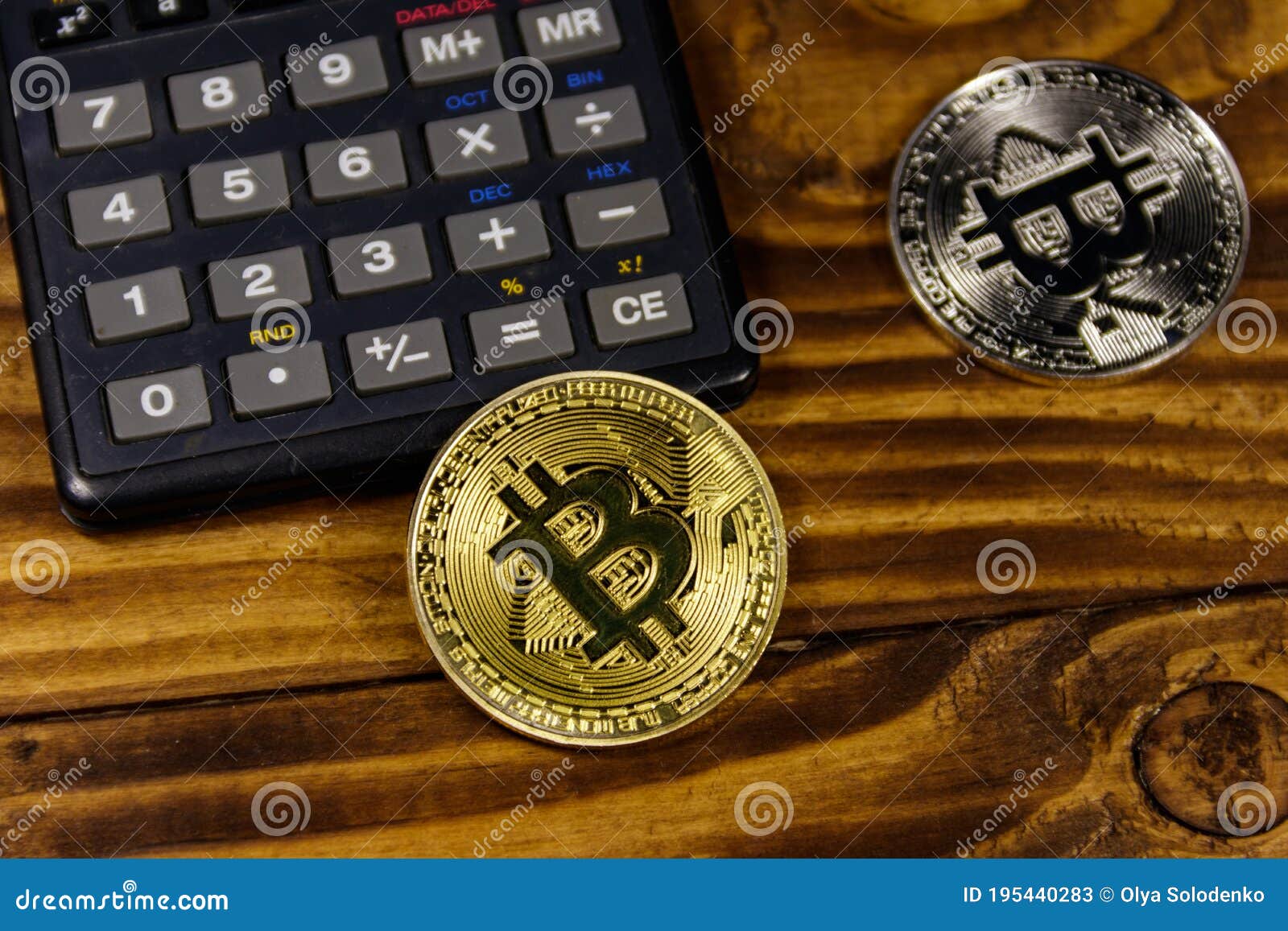 Two Bitcoins and Calculator on Wooden Desk Stock Image - Image of ...