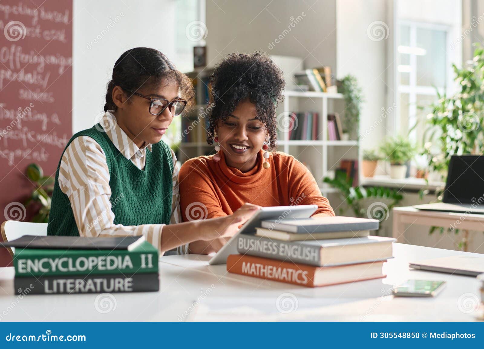 Two Black Girls Using Tablet in Class Stock Photo - Image of screen ...
