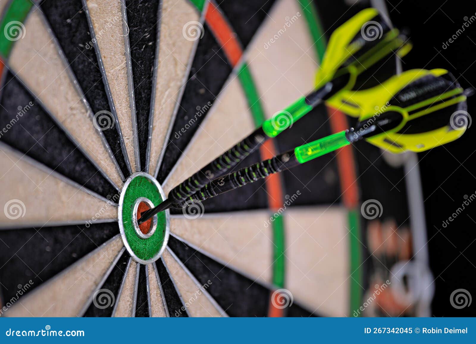 Two Black and Green Darts Stuck in the Bullseye of a Dartboard. Close ... Two Black and Green Darts Stuck in the Bullseye of a Dartboard. Close ...