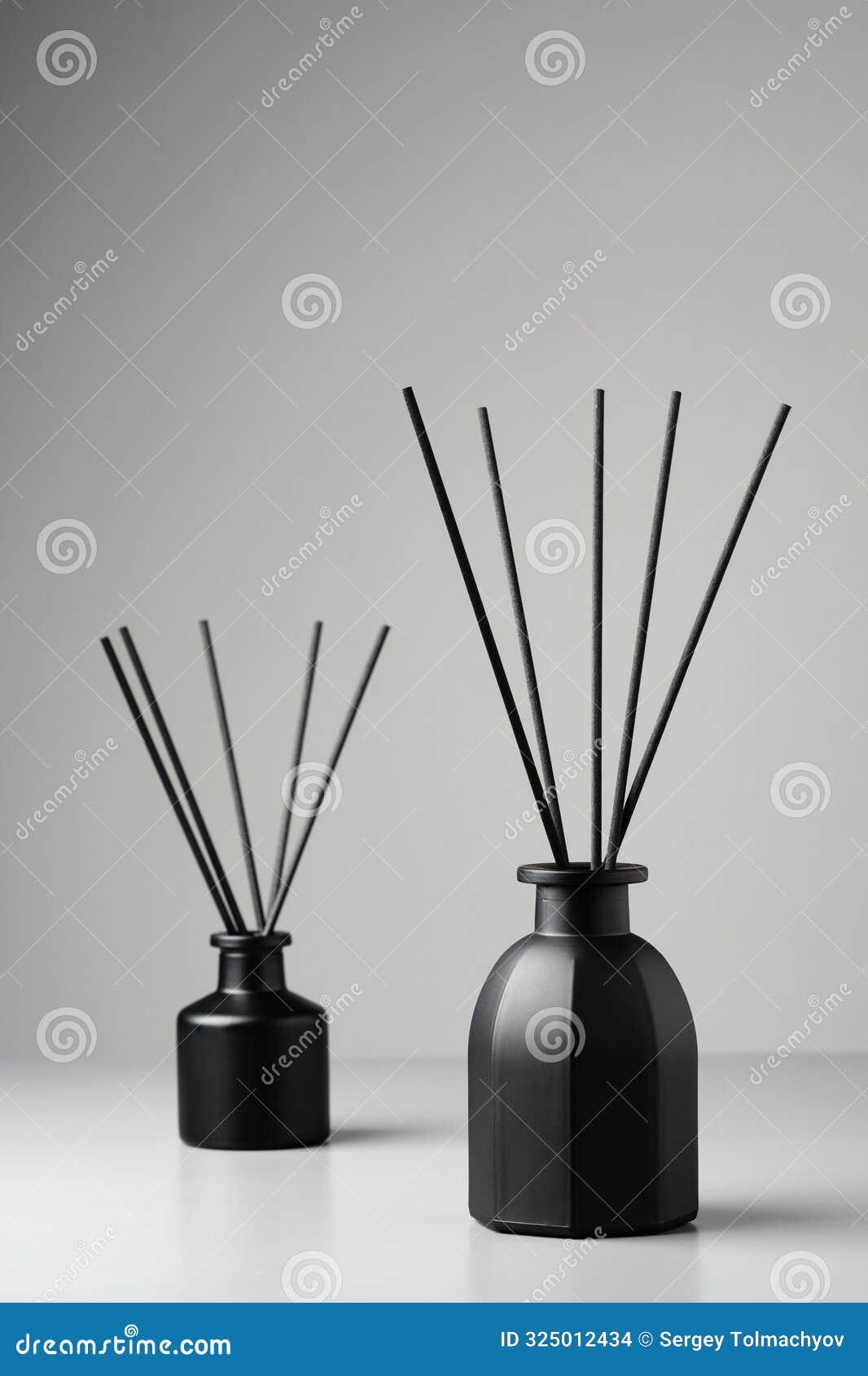 Two Black Reed Diffuser Bottles on a White Surface with Grey Background ...