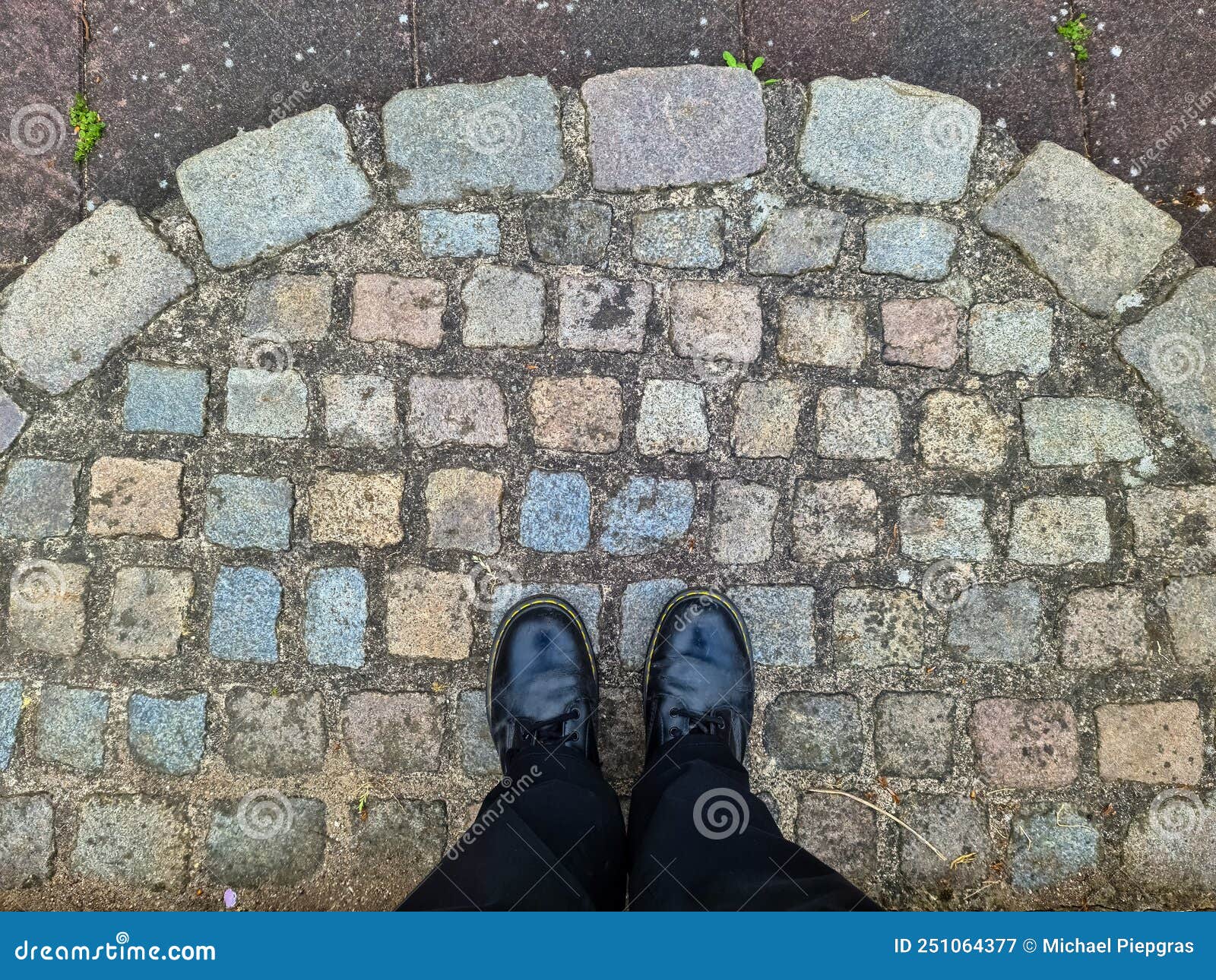 Two Black Shoes and Legs on a Cobblestone Surface - Top View Concept ...