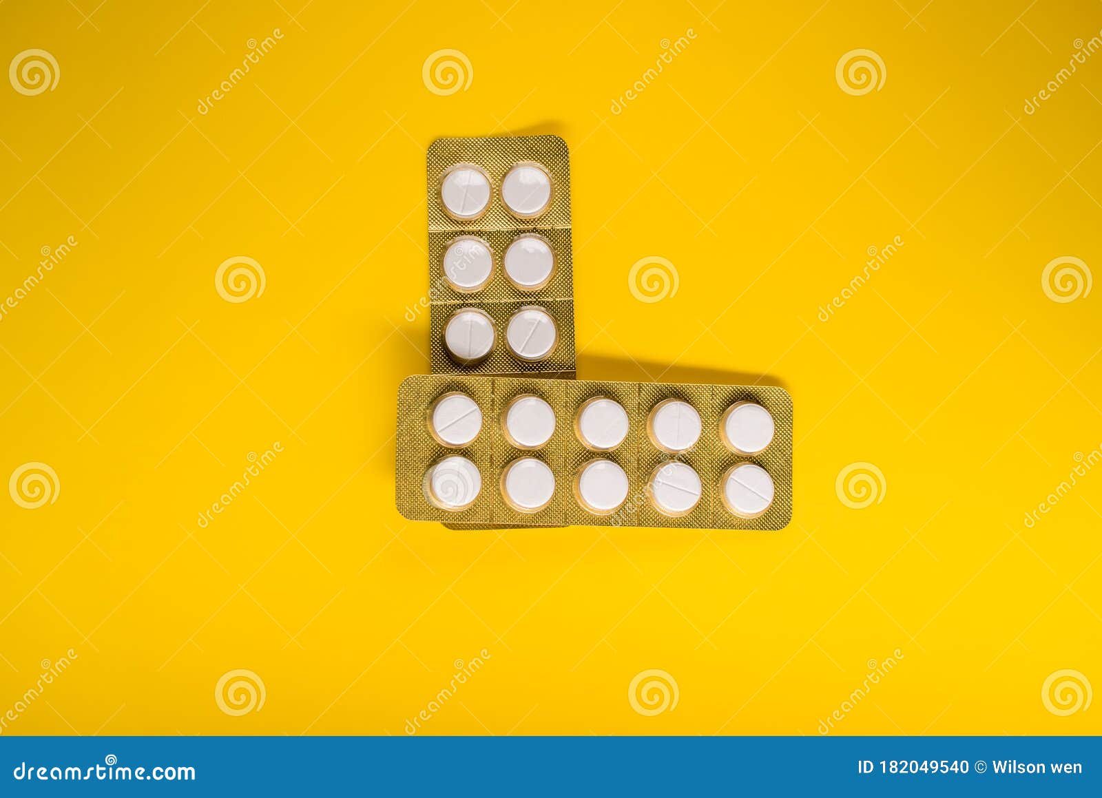 Two Blister of White Pills Horizontal and Vertical on a Yellow ...