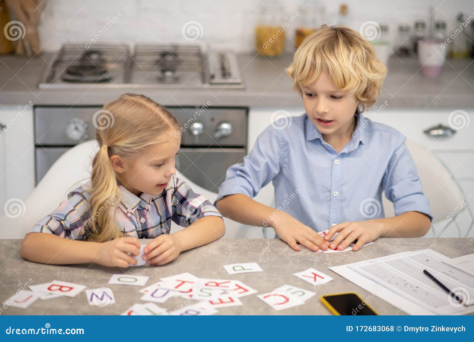Two Blond Kids Making Words and Feeling Involved Stock Photo - Image of ...