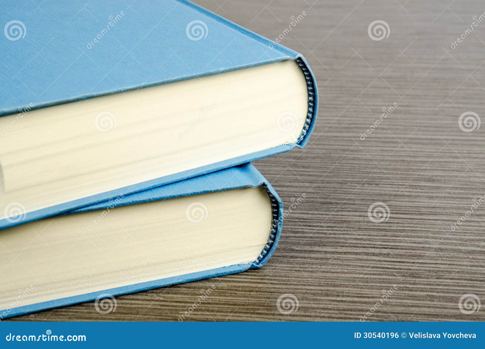 Two Blue Books on a Table with Wooden Texture Stock Photo - Image of ...