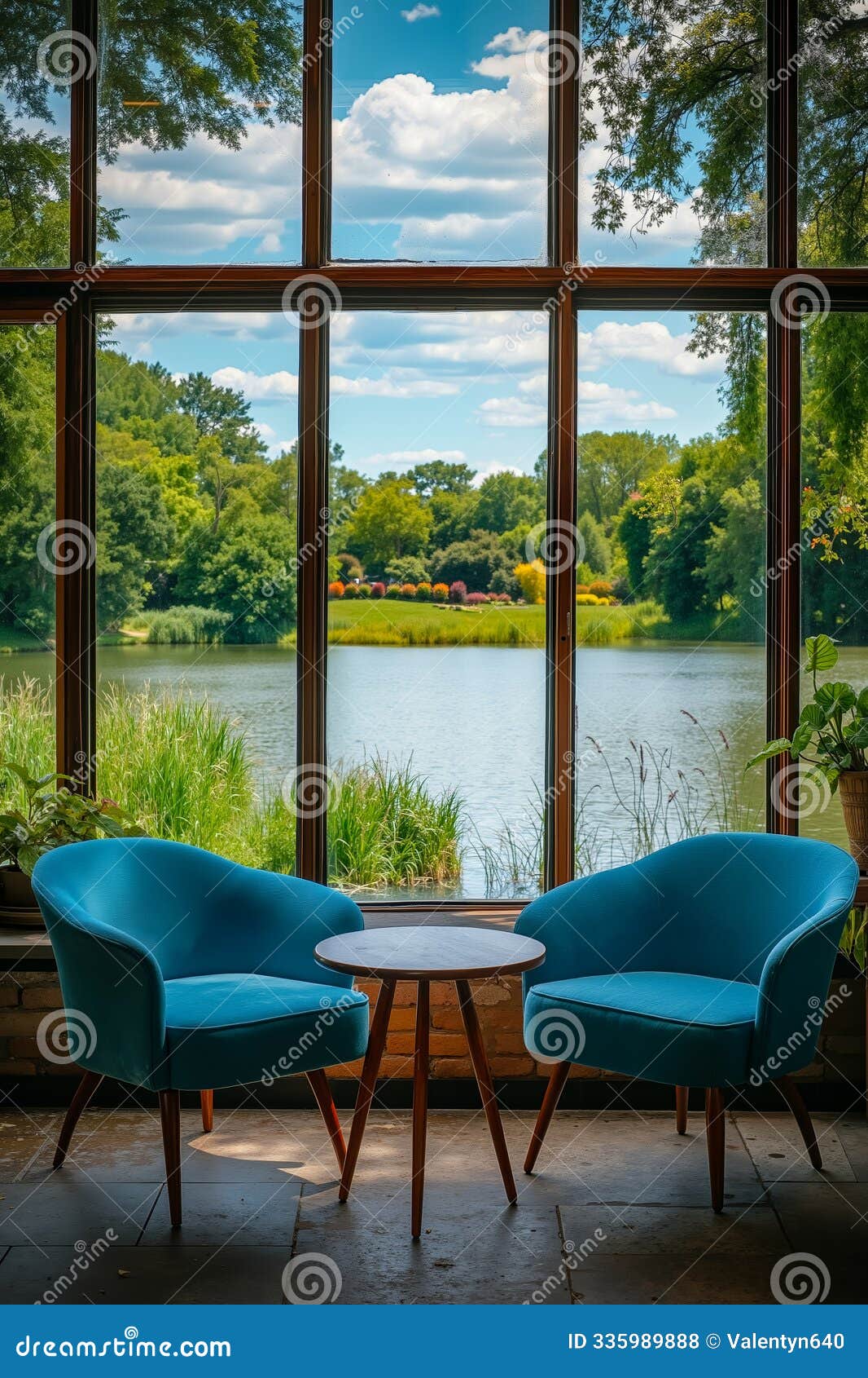 Two Blue Chairs and a Table in Front of a Large Window Stock Photo ...