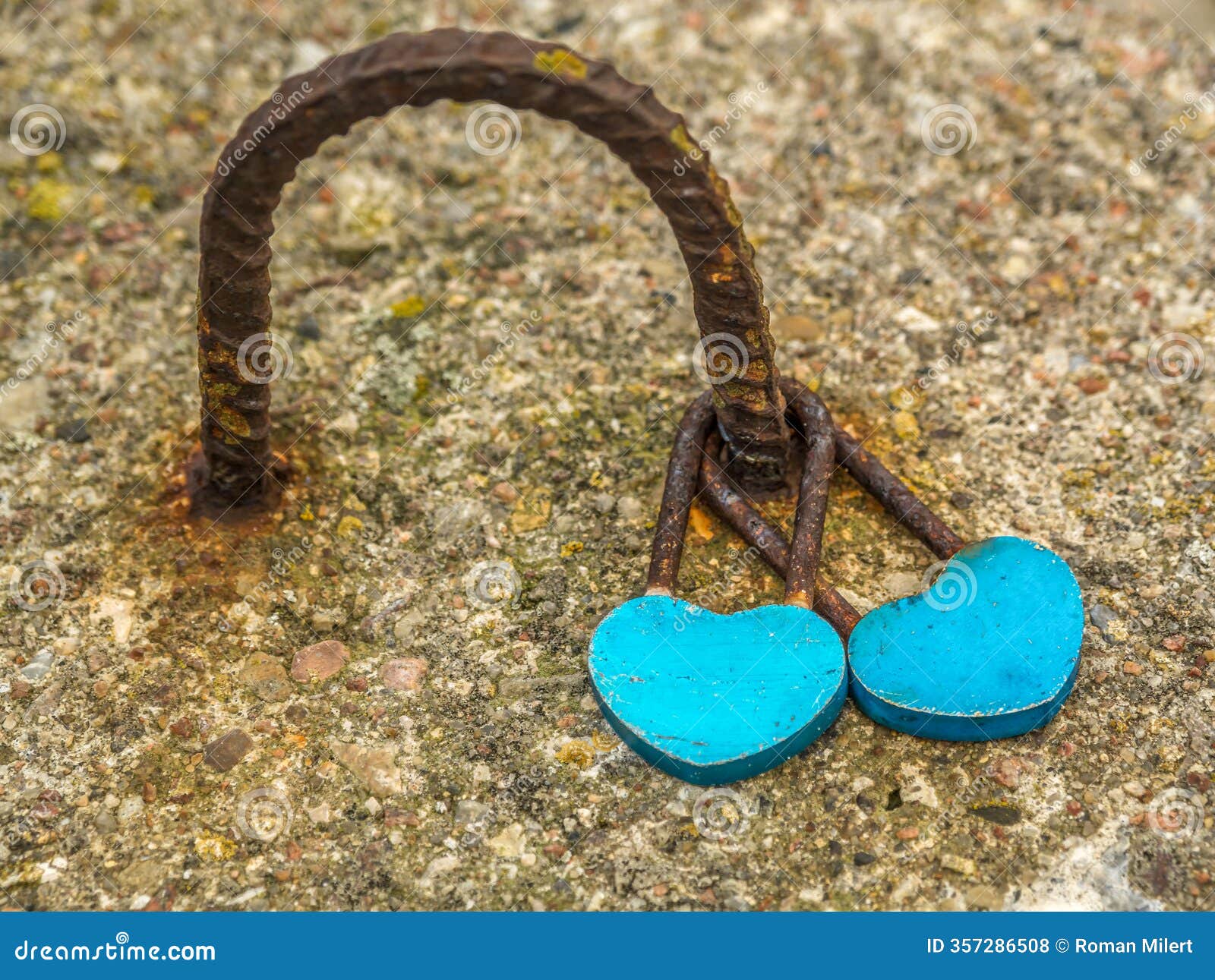 Two Blue Heart Padlocks Fastened To a Rusty Metal Loop on Concrete ...