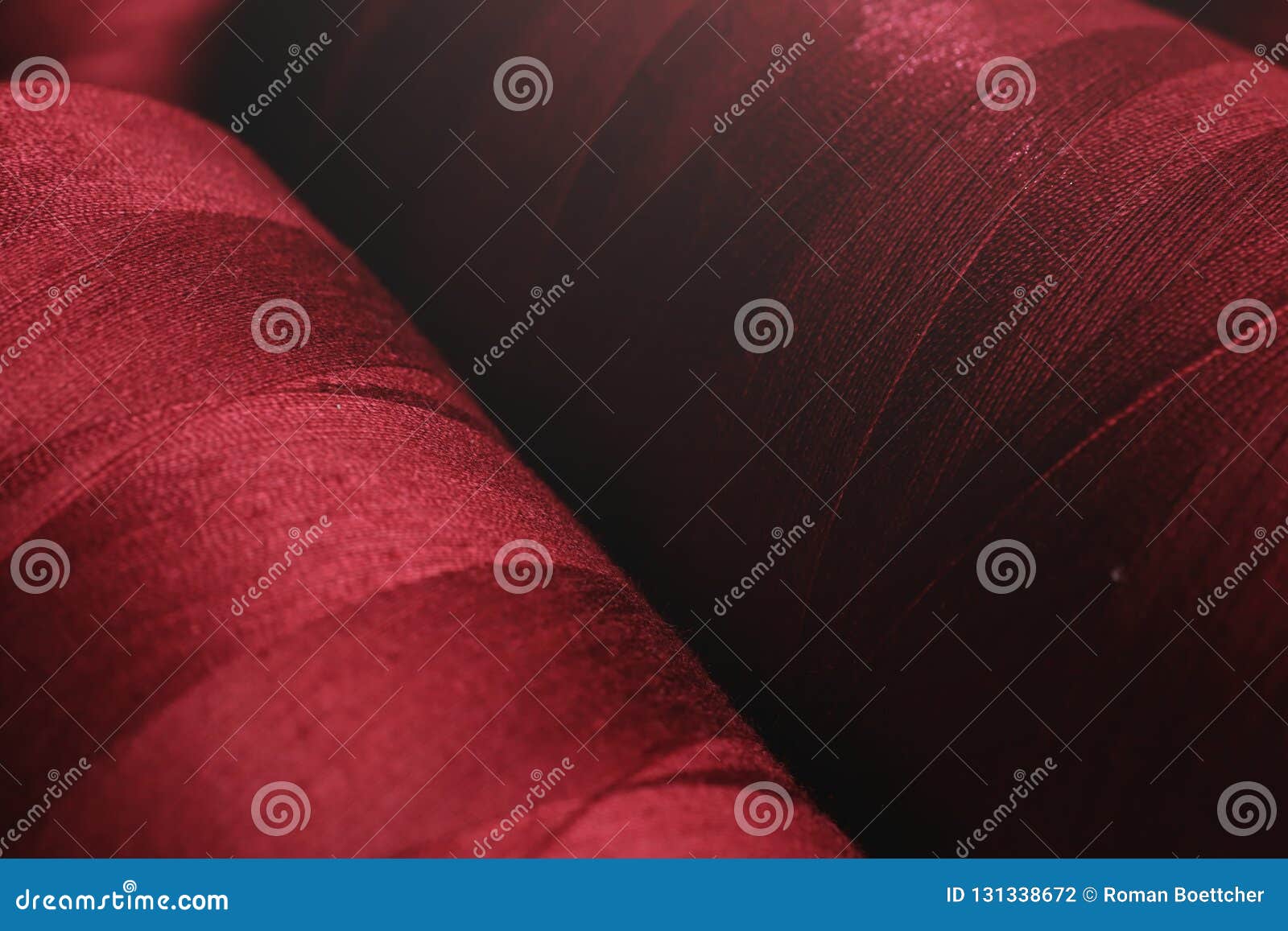 Two Bobbins with Neat Wound Deep Red Thread in Bright Light Stock Photo ...