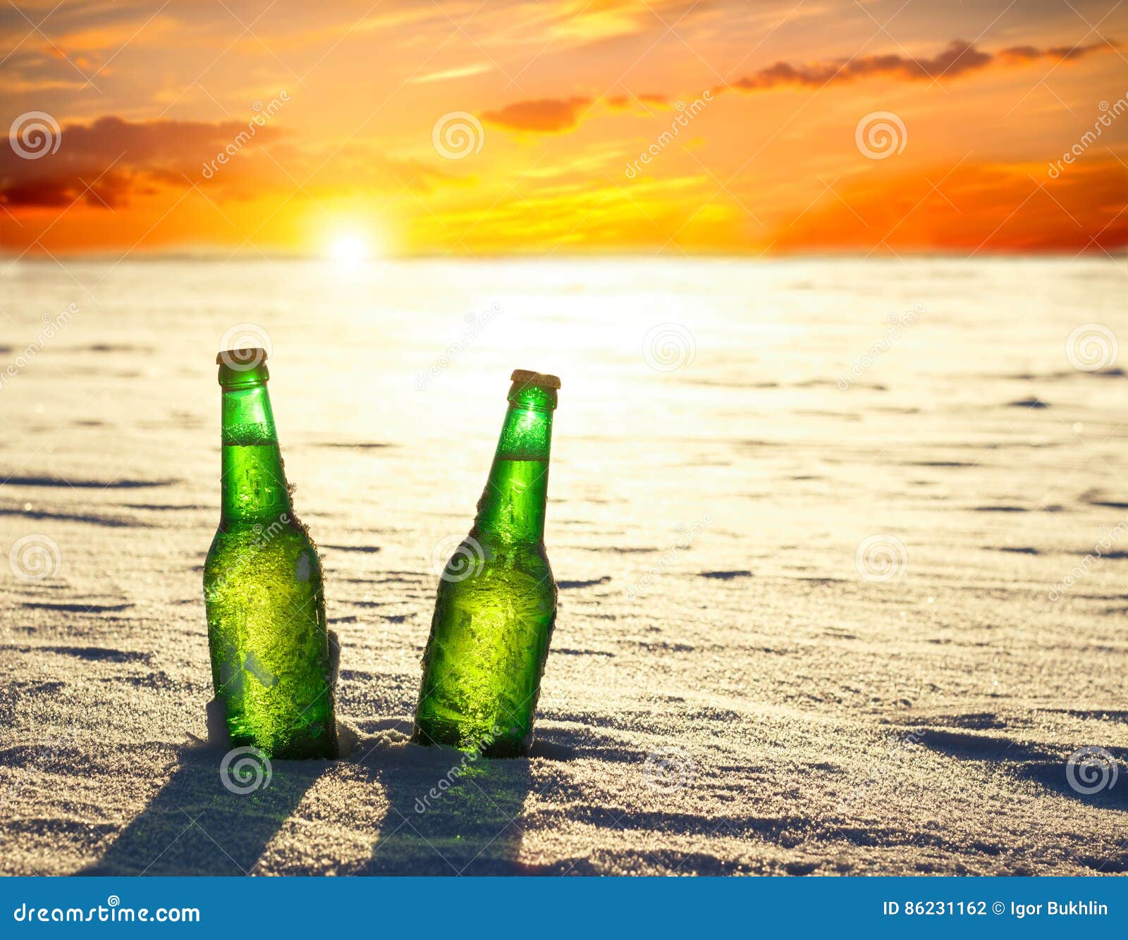 Two Bottles of Cold Beer on the Snow at Sunset Stock Photo - Image of ...
