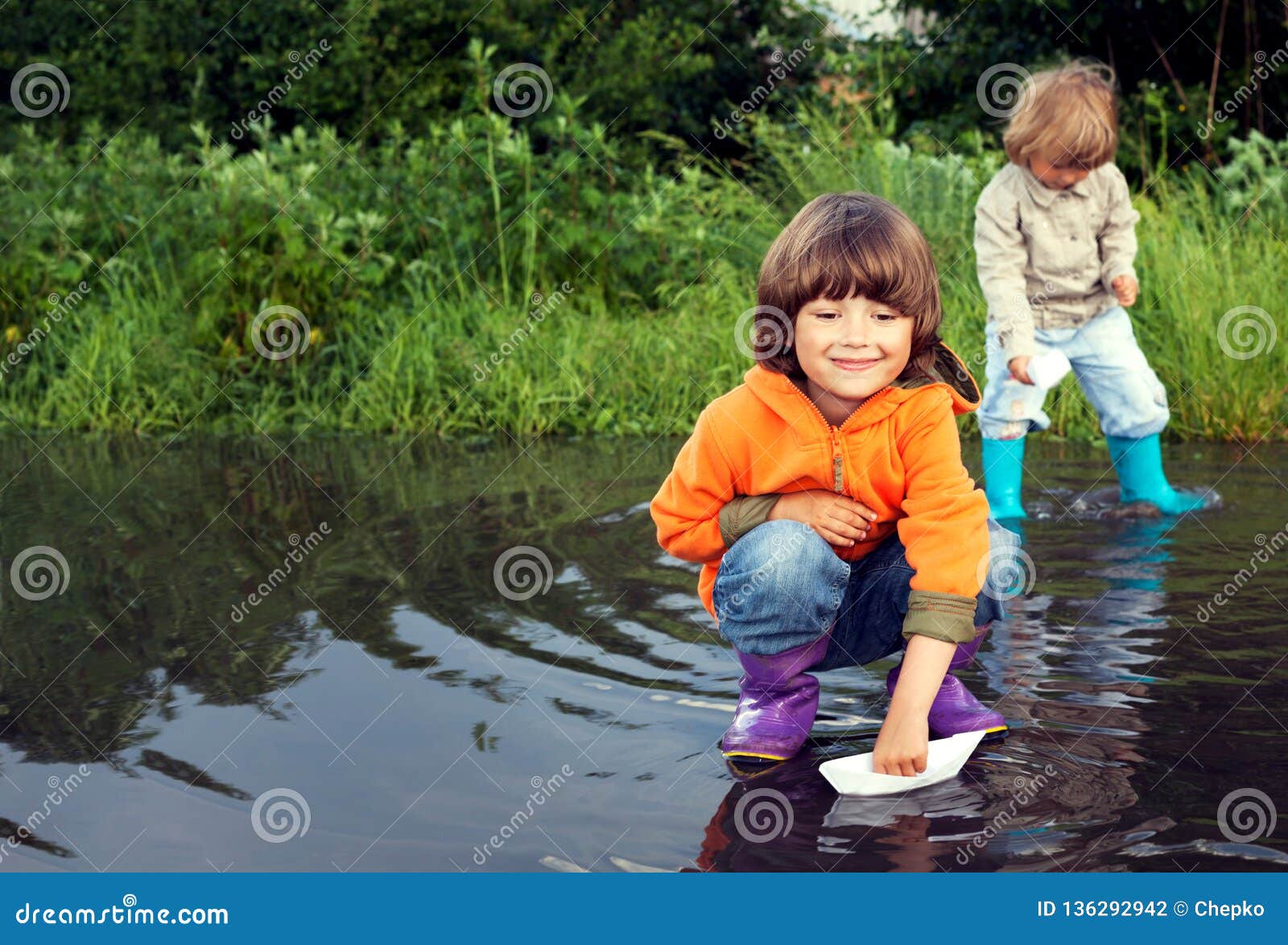 Two boy play in puddle stock photo. Image of caucasian - 136292942