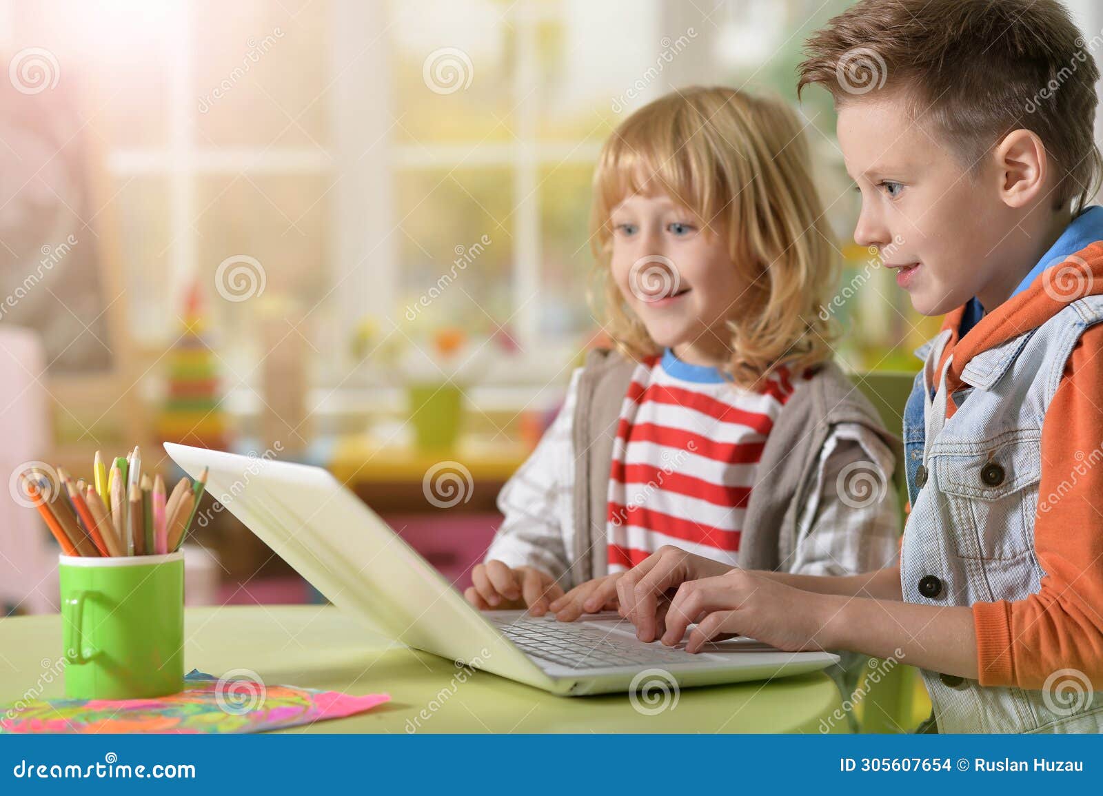 Two Boys at Class Using Laptop and Writing Stock Photo - Image of face ...