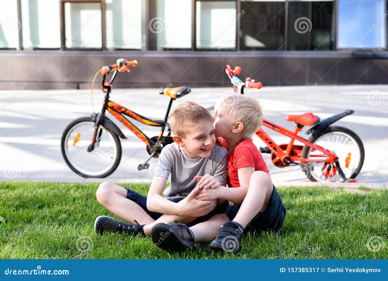 Two Boys Communicate Sitting on the Grass. Rest after Cycling, Bicycles ...